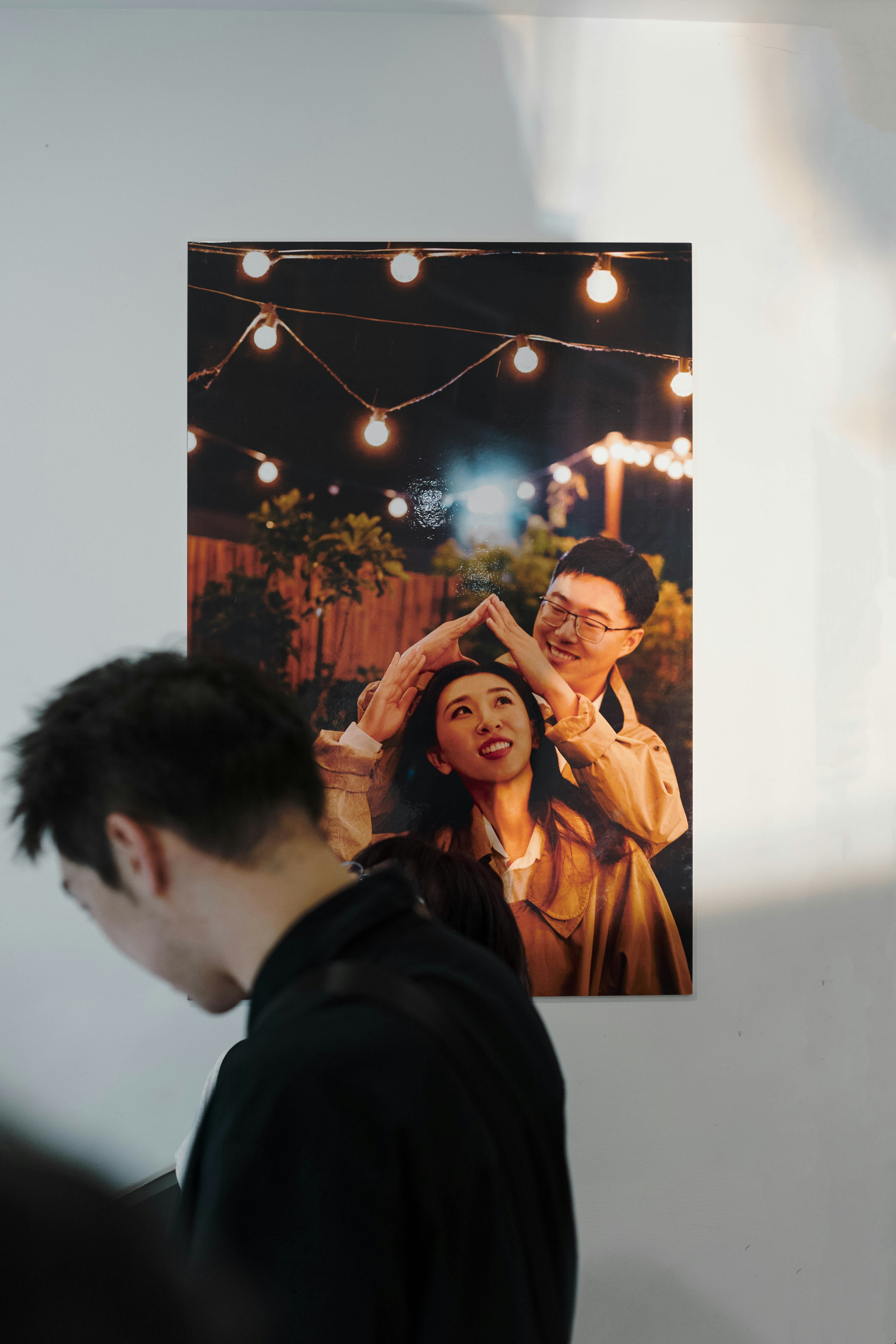 A poster of a loving couple is hanging.