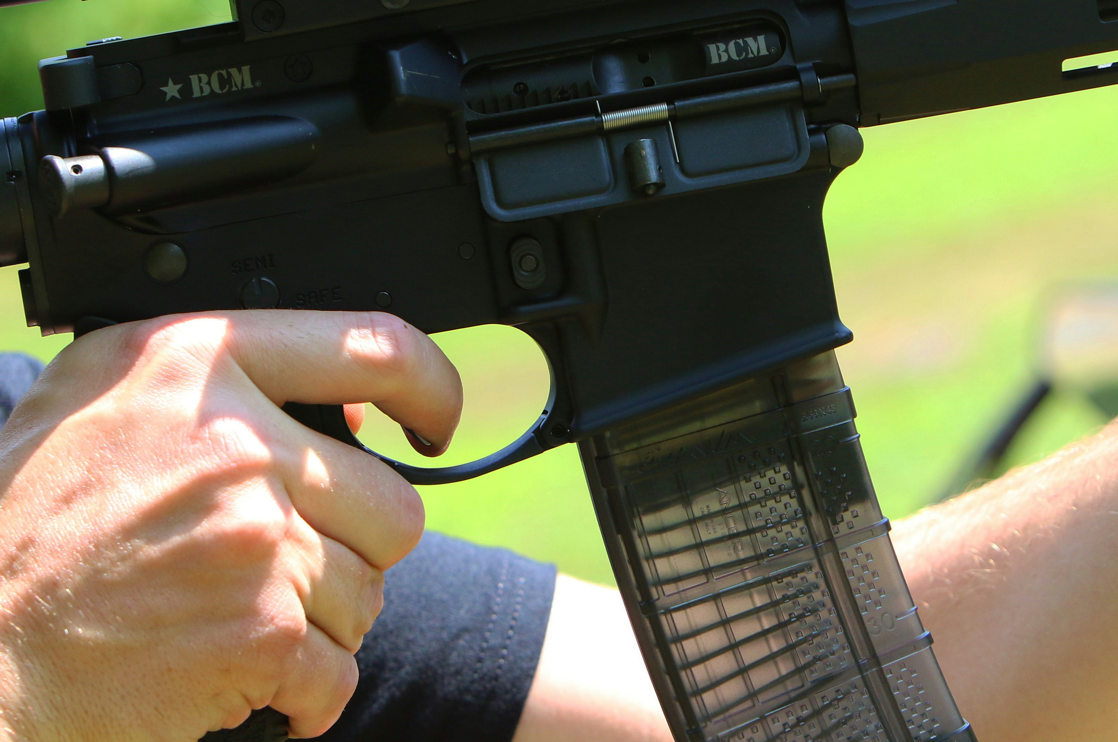 Gripped Mechanism: Close-up of a Rifle and Magazine in Focus