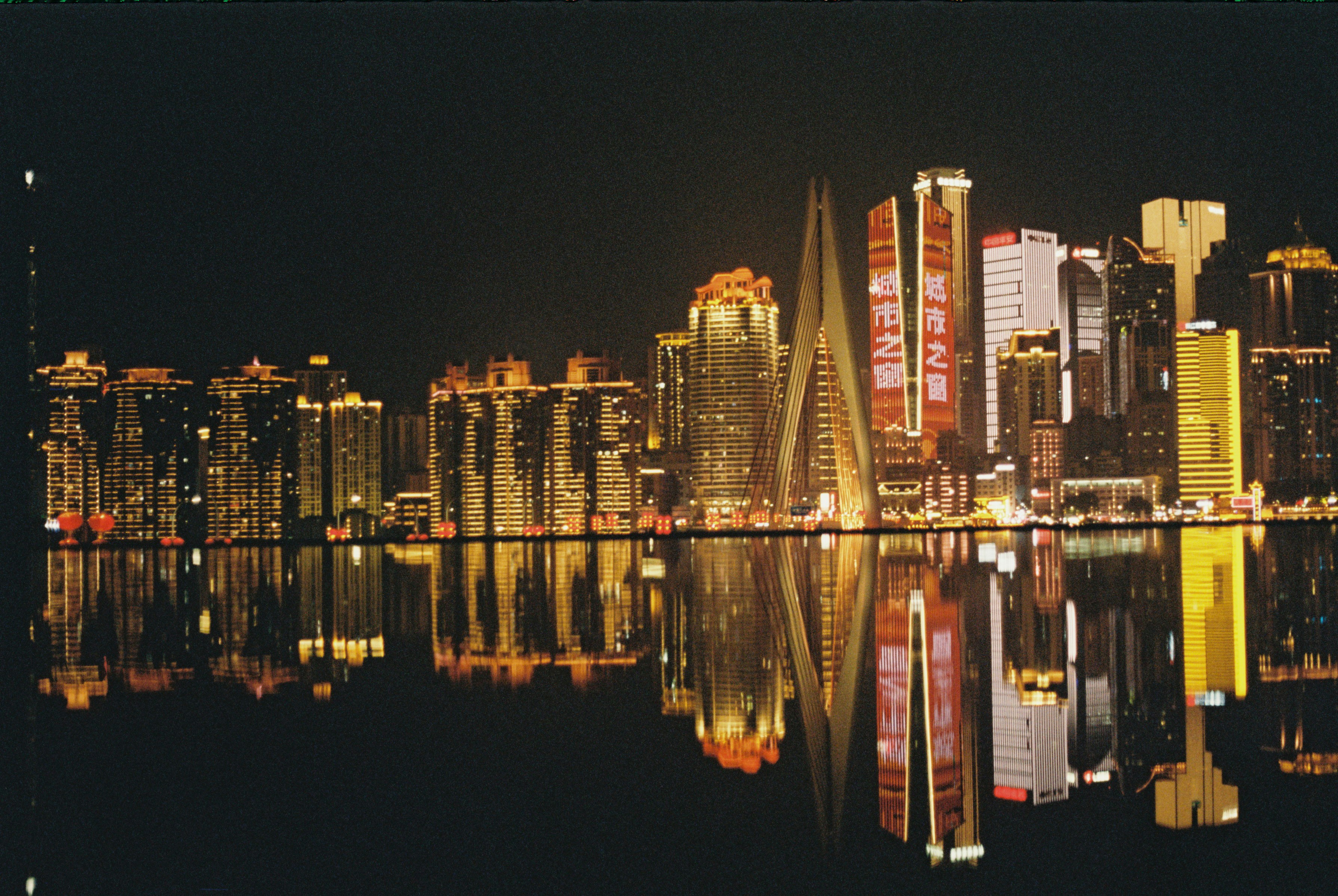 City lights beautifully reflected in water at night.