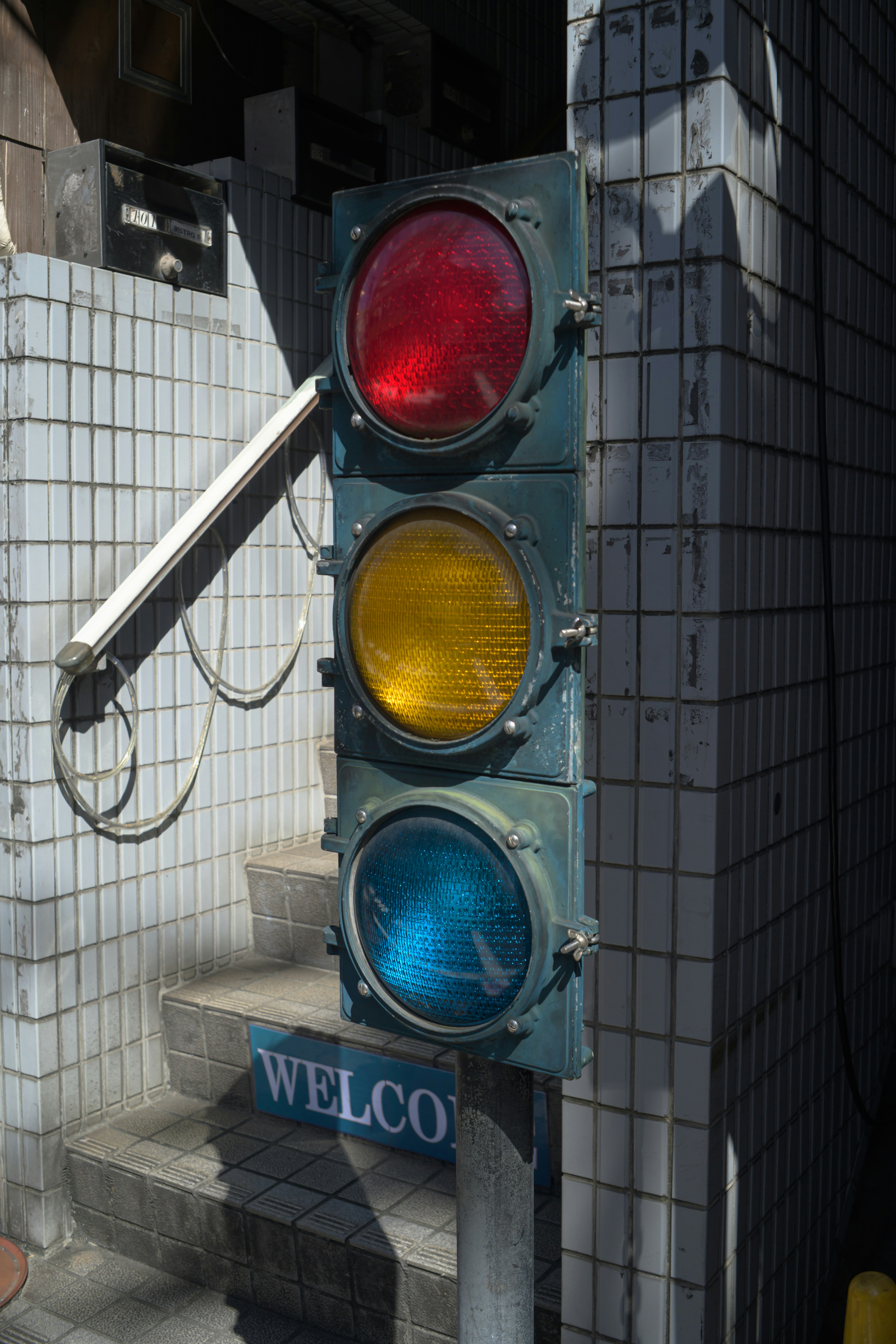 Traffic light is showing red, yellow, and blue lights.