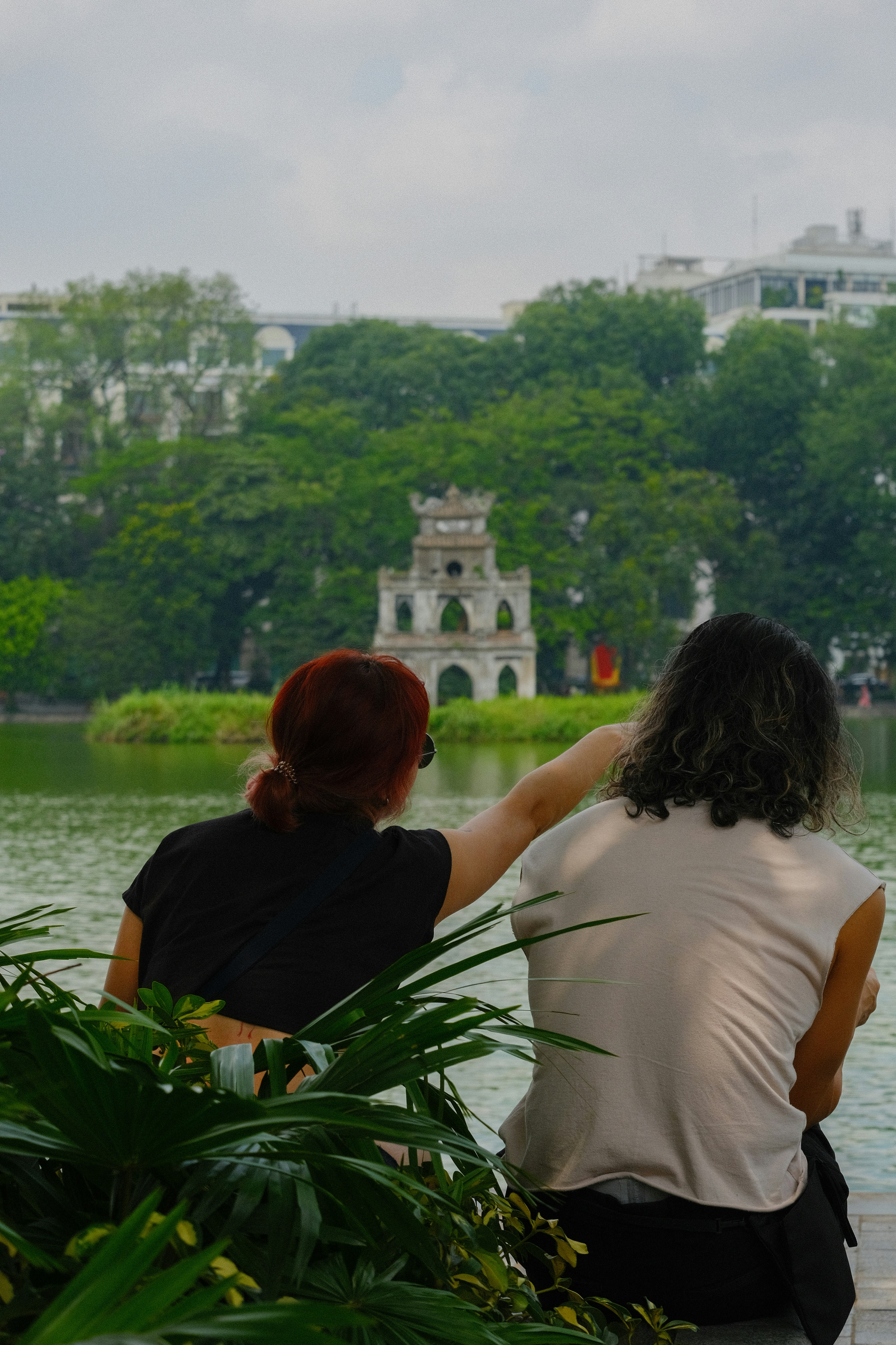 Two people enjoy a view of a temple.
