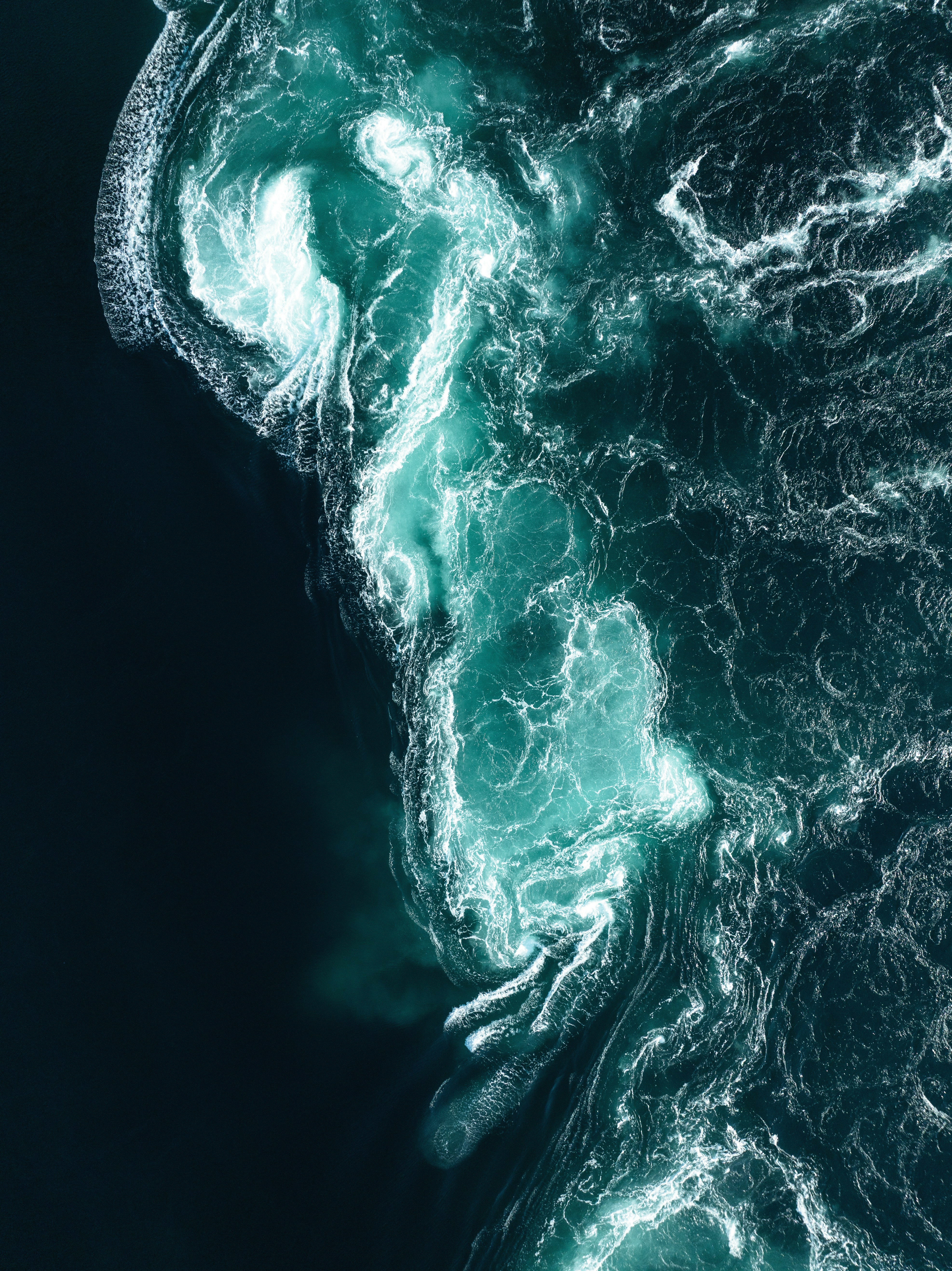 Turbulent, turquoise water creates a beautiful ocean pattern.