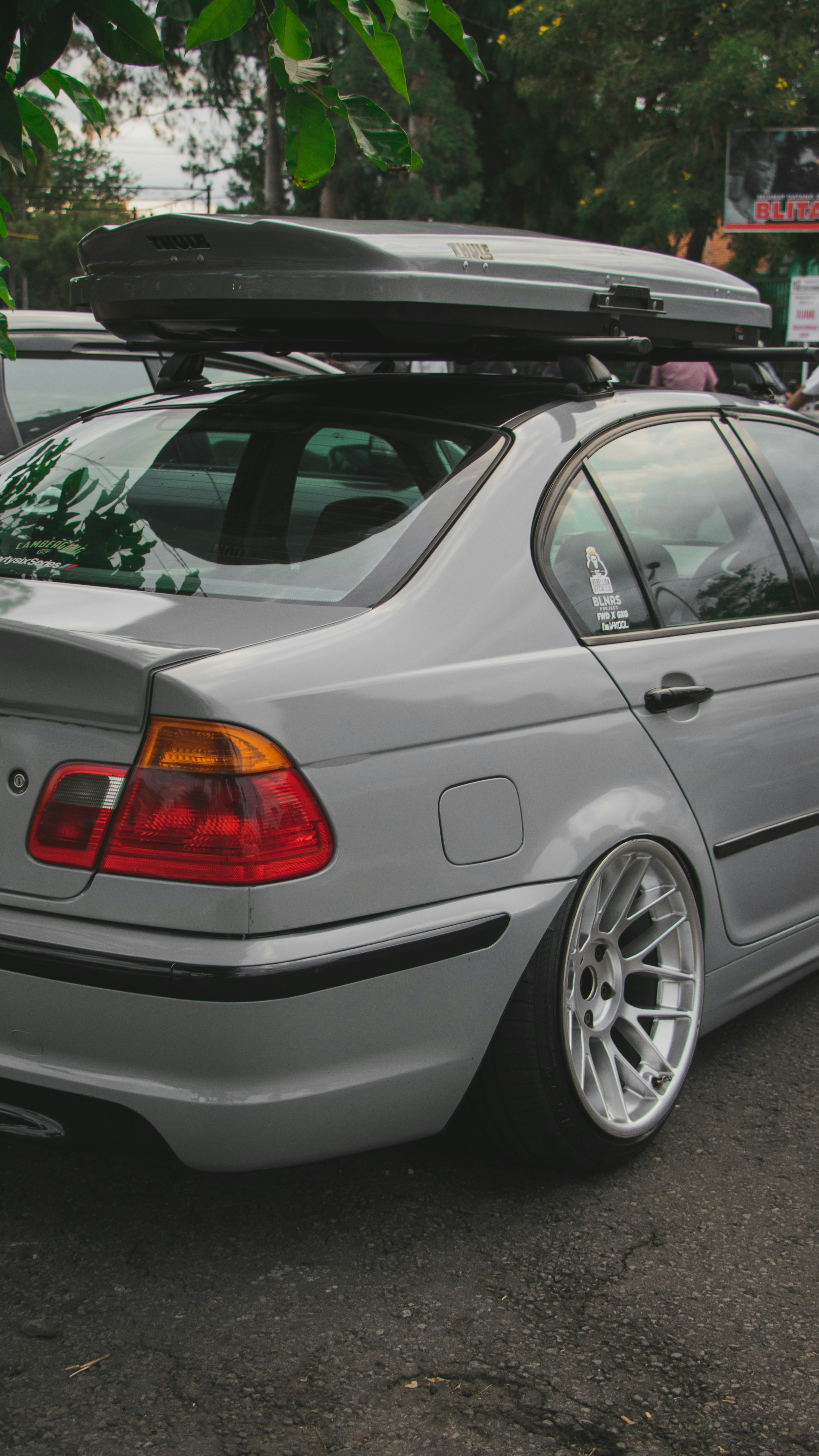 STANCE BMW E46 WITH ROOFBOX | A silver car with a roof rack.