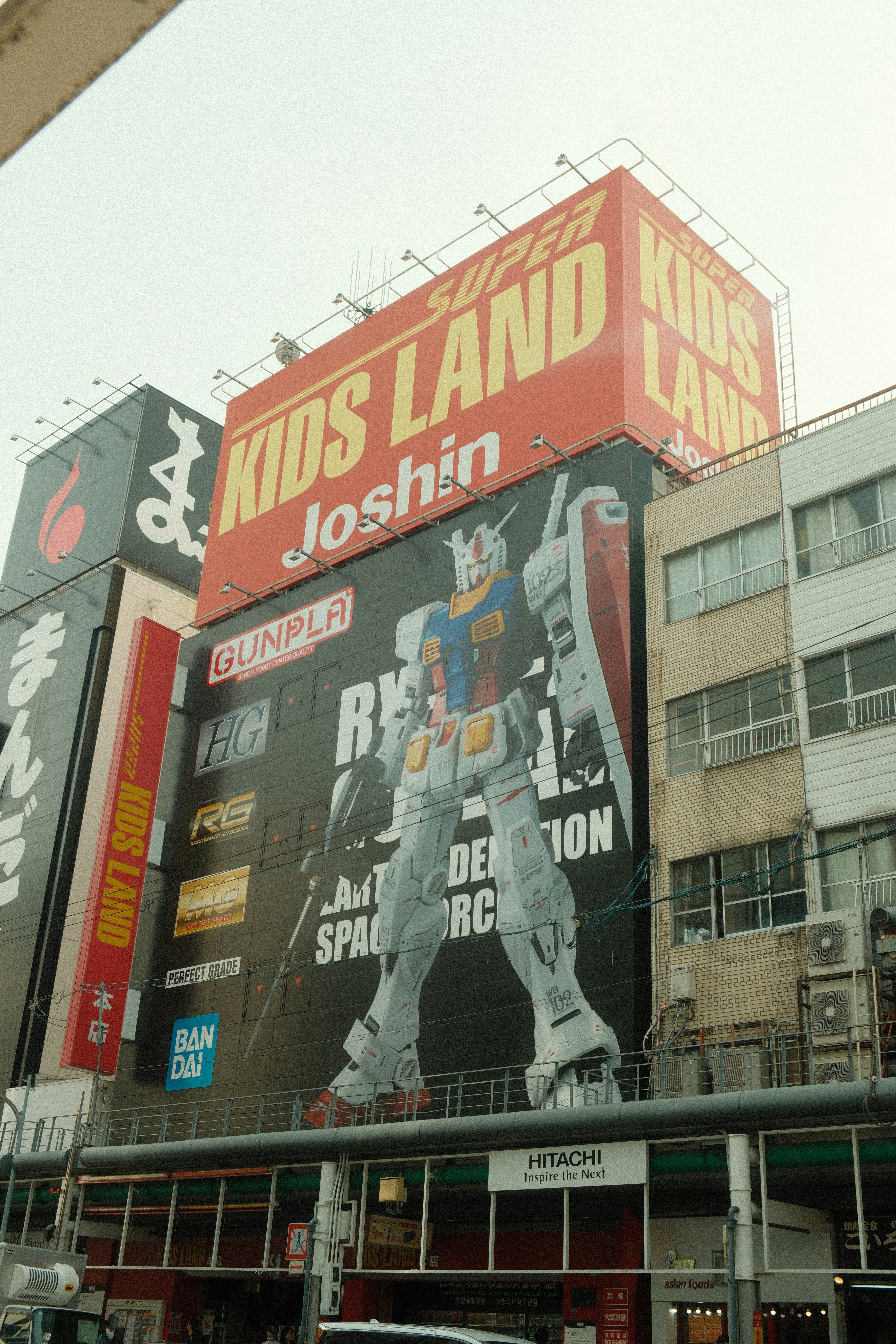A giant gundam advertisement on a building in japan.
