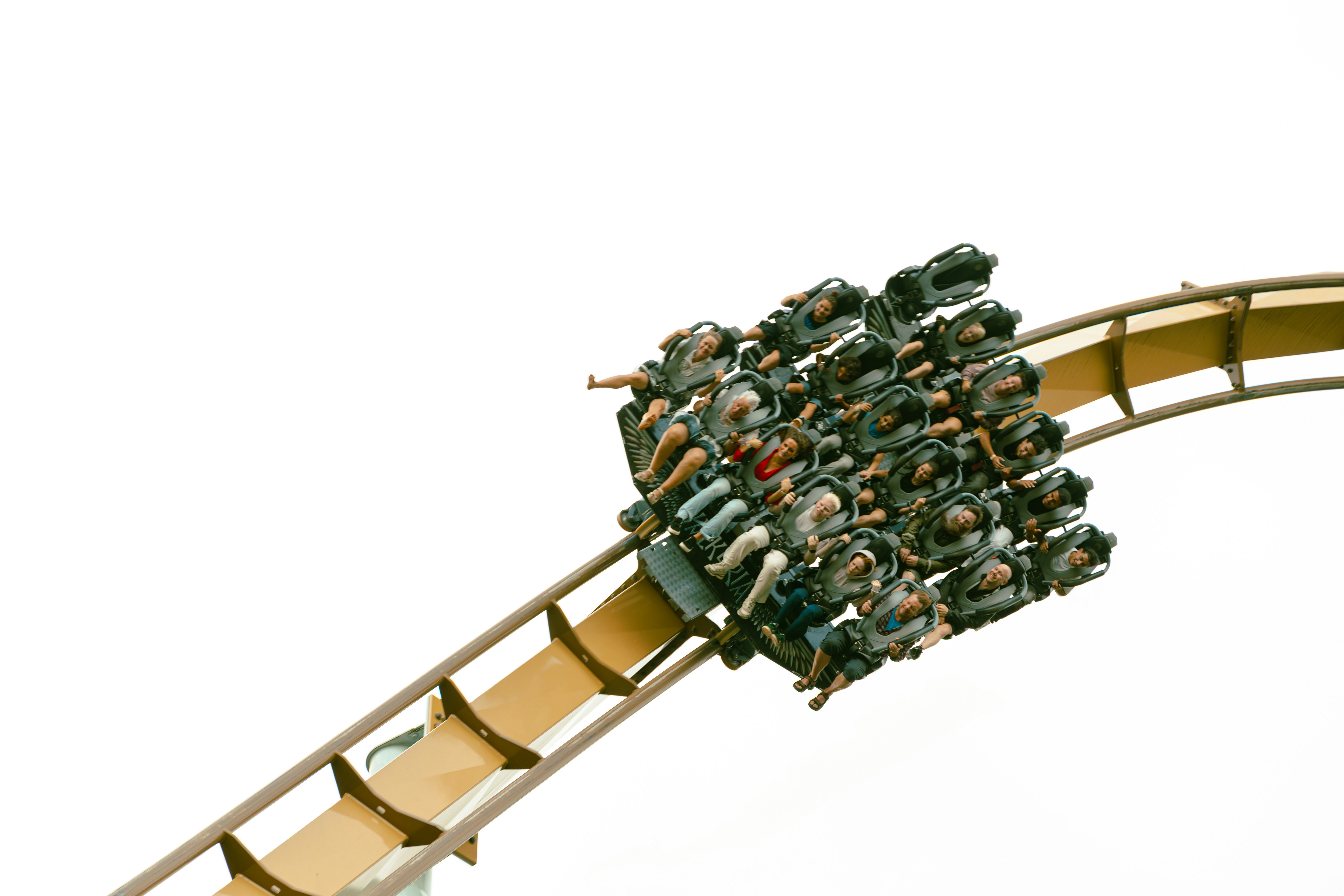 Roller coaster cars going up a steep hill.