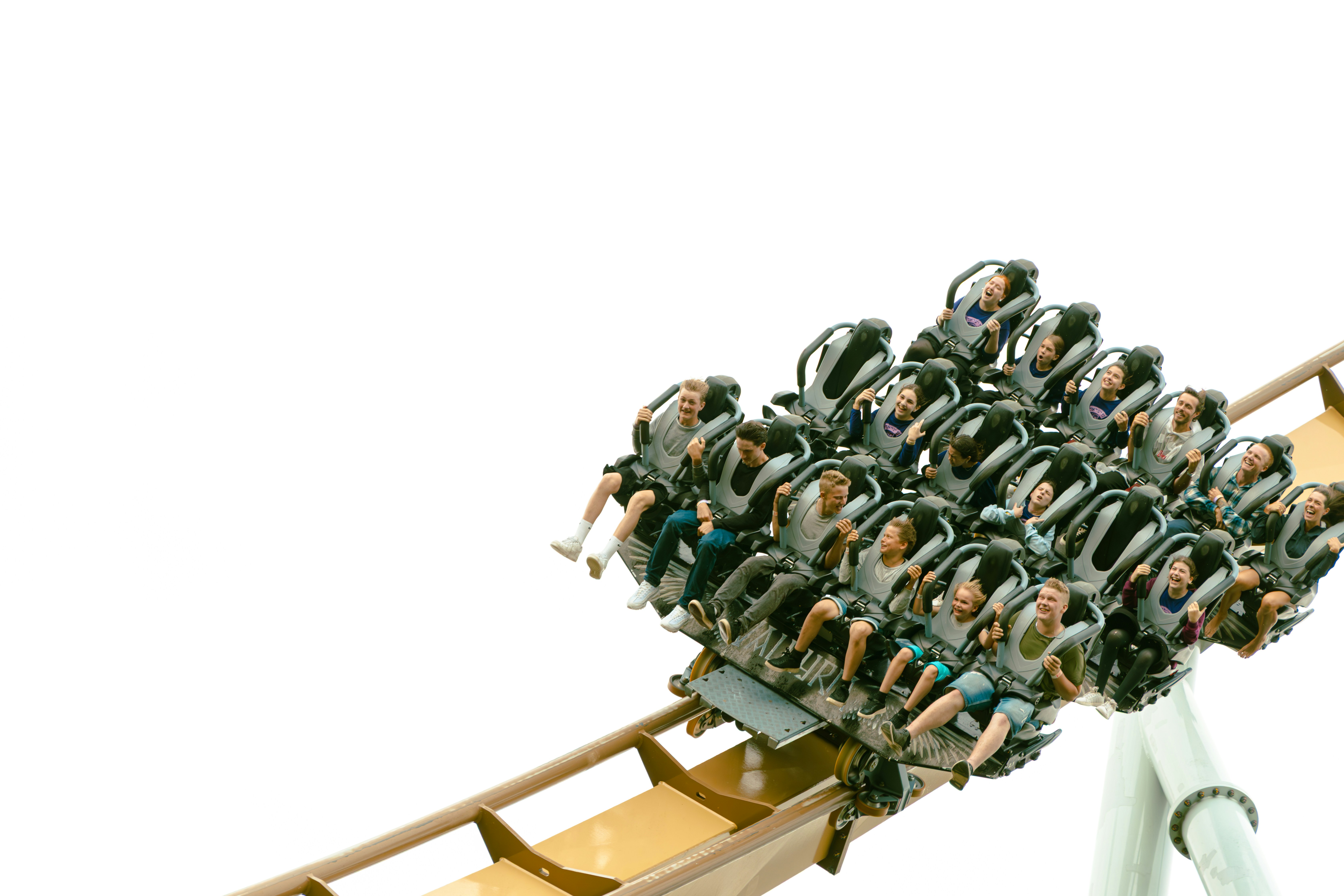 Roller coaster racing downhill with many riders.