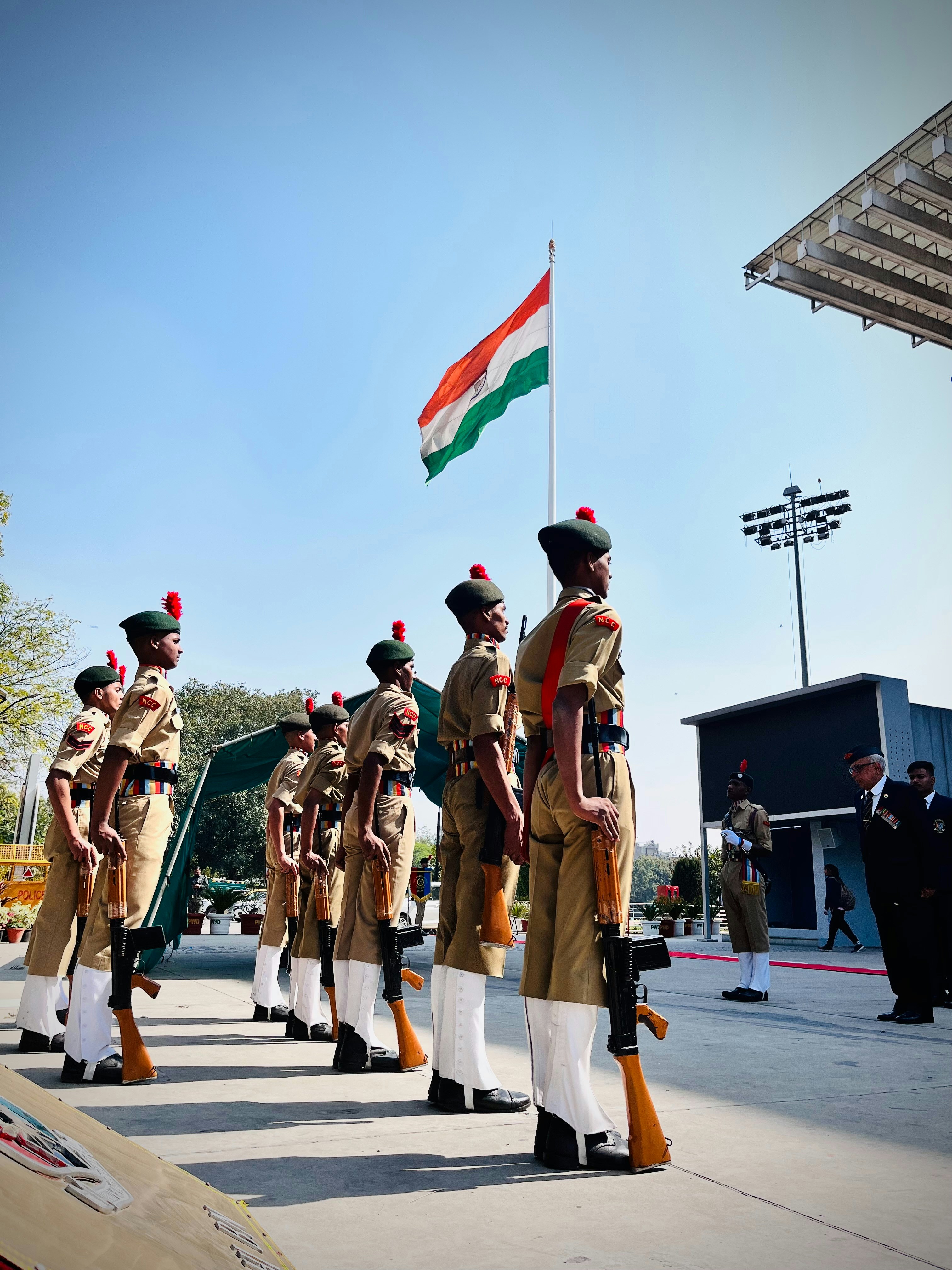 Unity & Discipline. | Indian soldiers stand at attention under the flag.