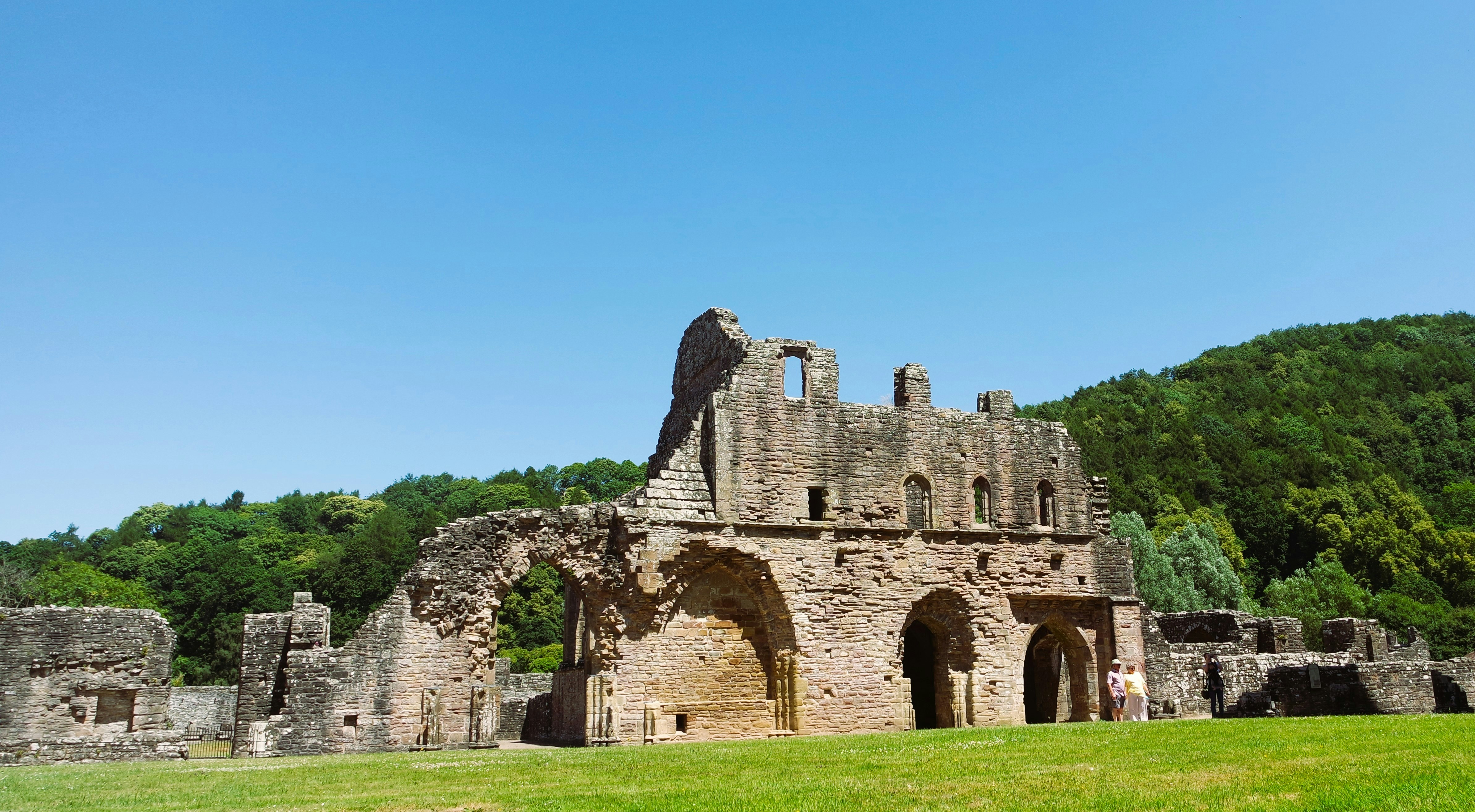 Ruins of an old structure stand under blue skies