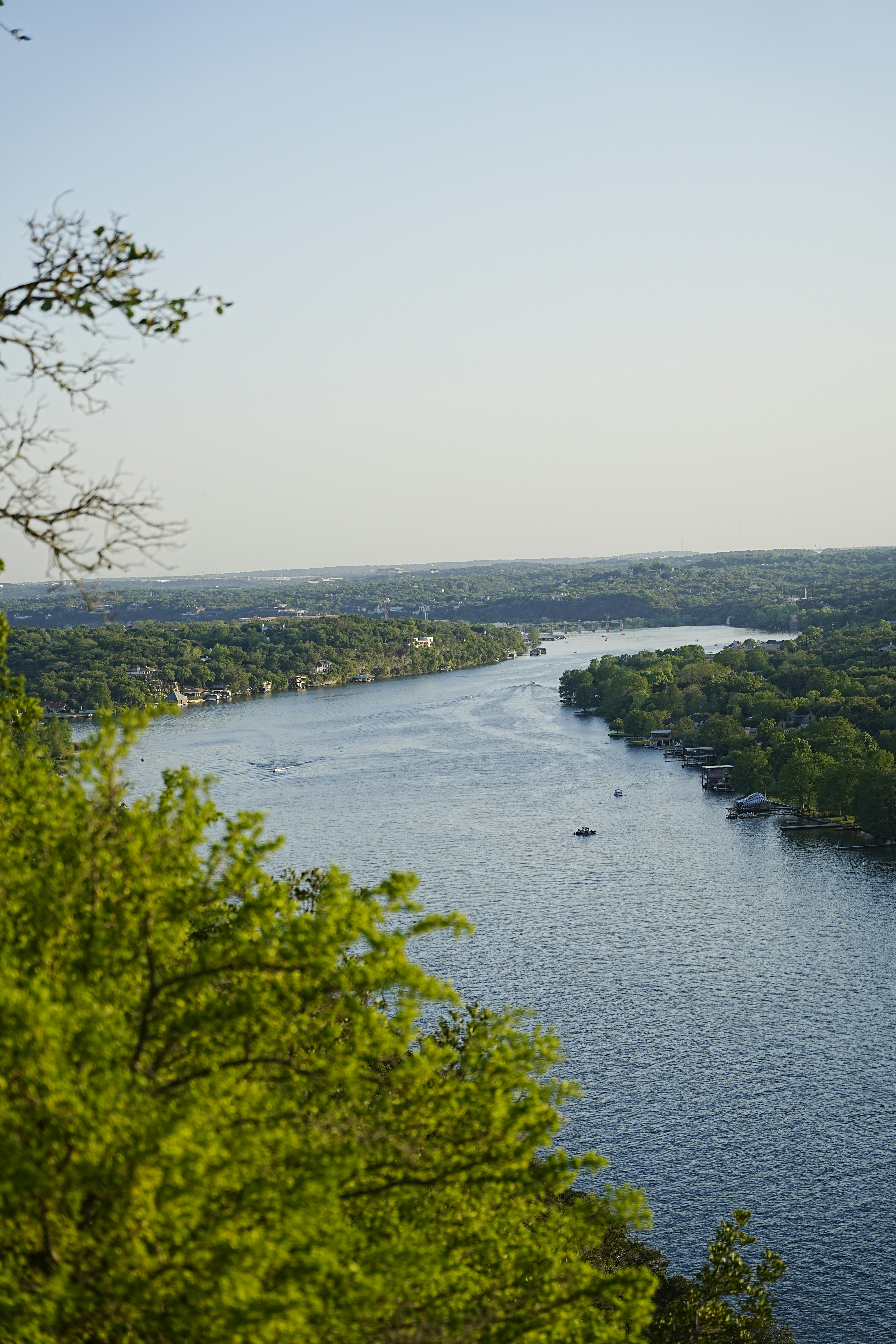 A wide river winds through a lush, green landscape.