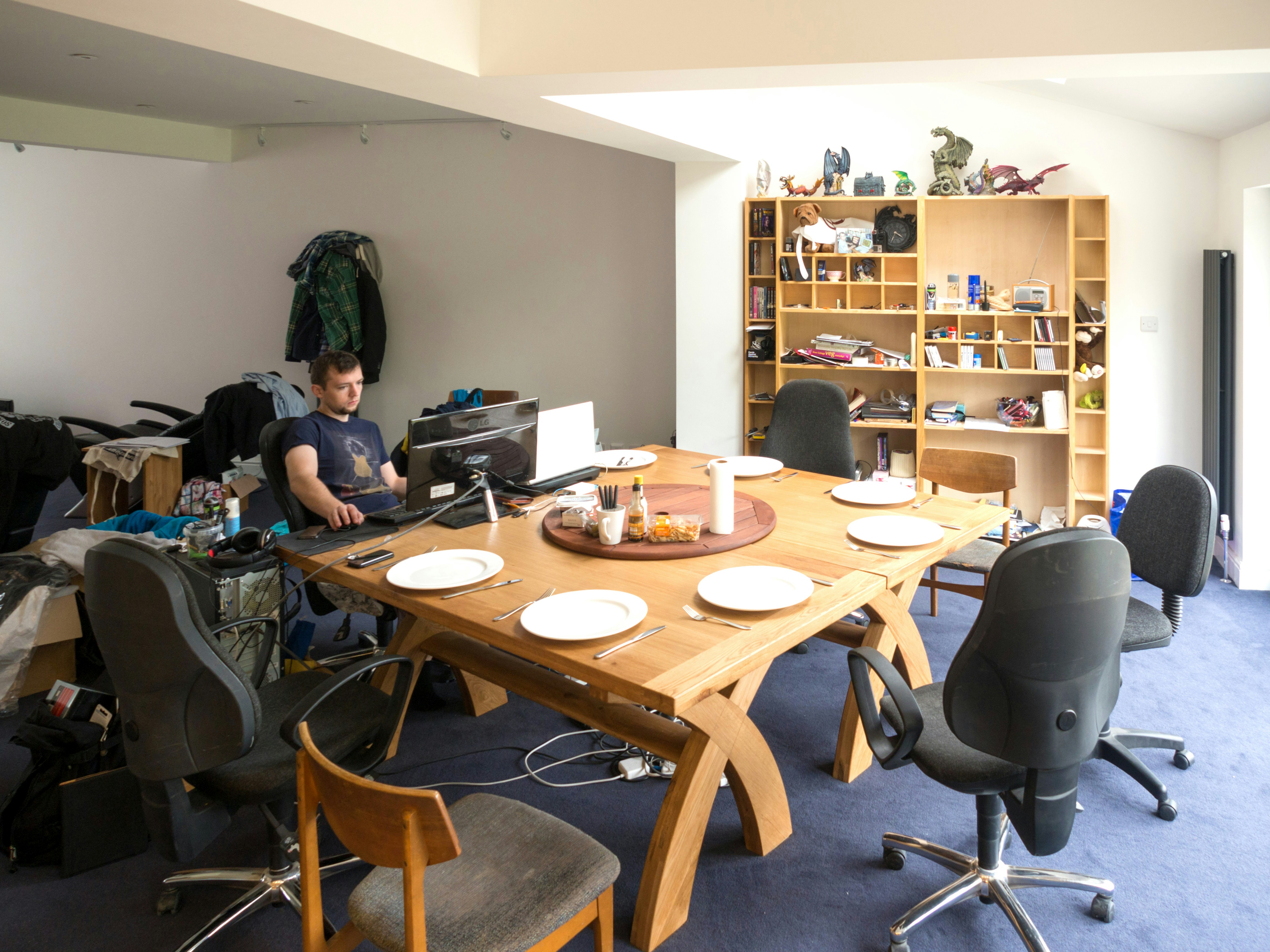 building work, building project, building, extension, builders, home improvement, grand designs, builders, home extension, house, home, home upgrade, update, renovation, DIY, | A man works at a table in a messy room.