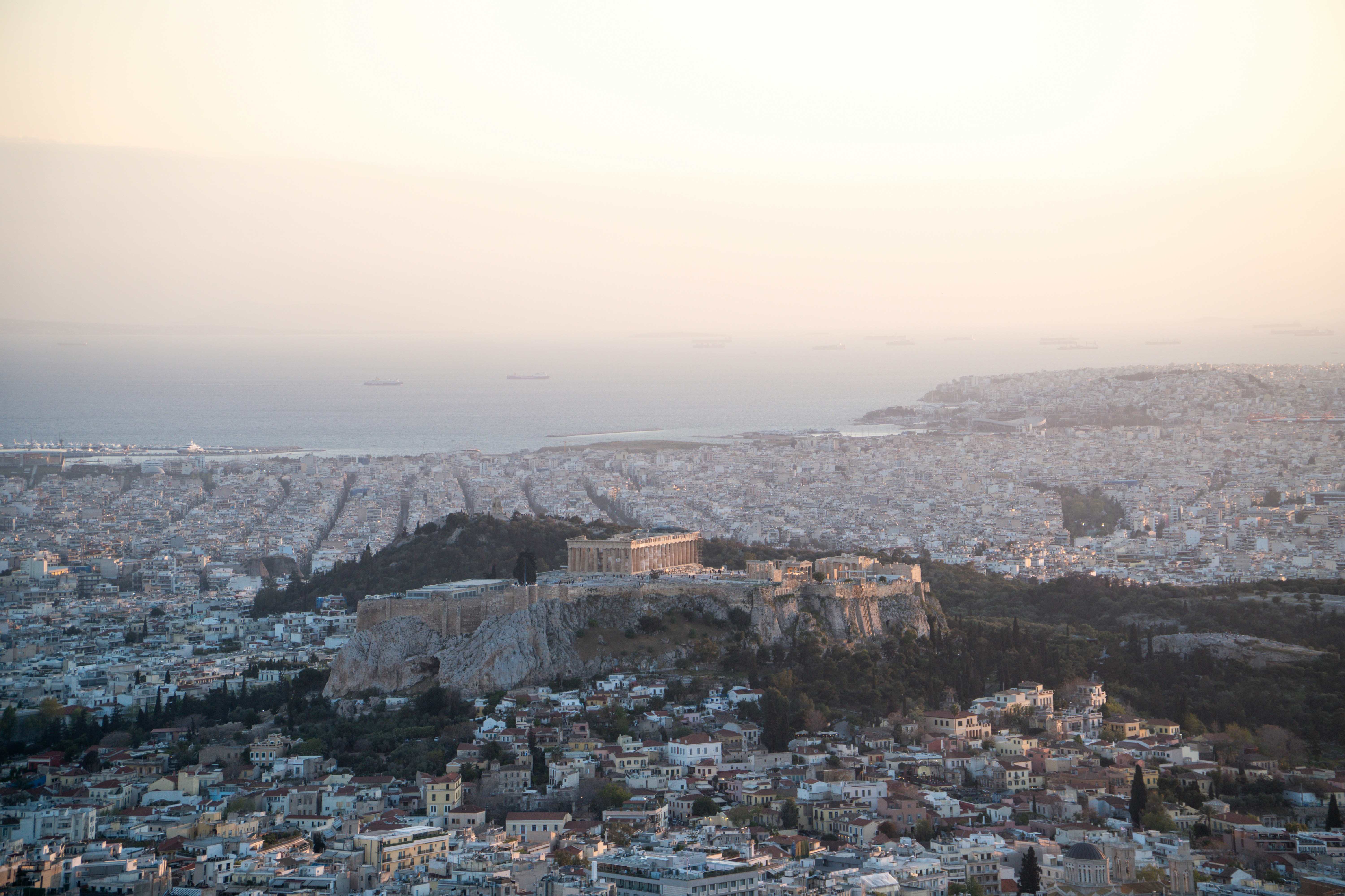 The acropolis of athens is seen at dusk.