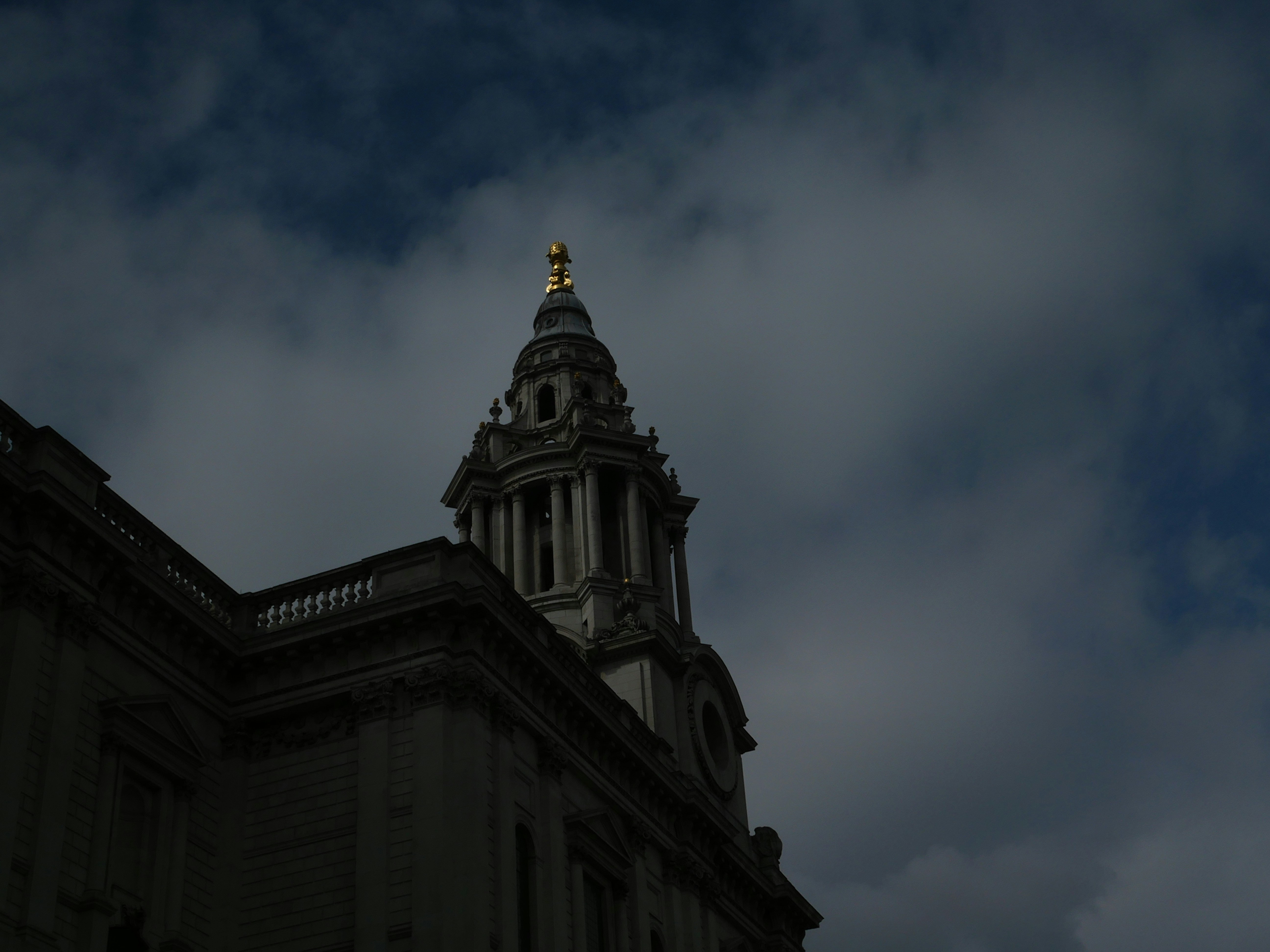 Church spire against a cloudy sky.