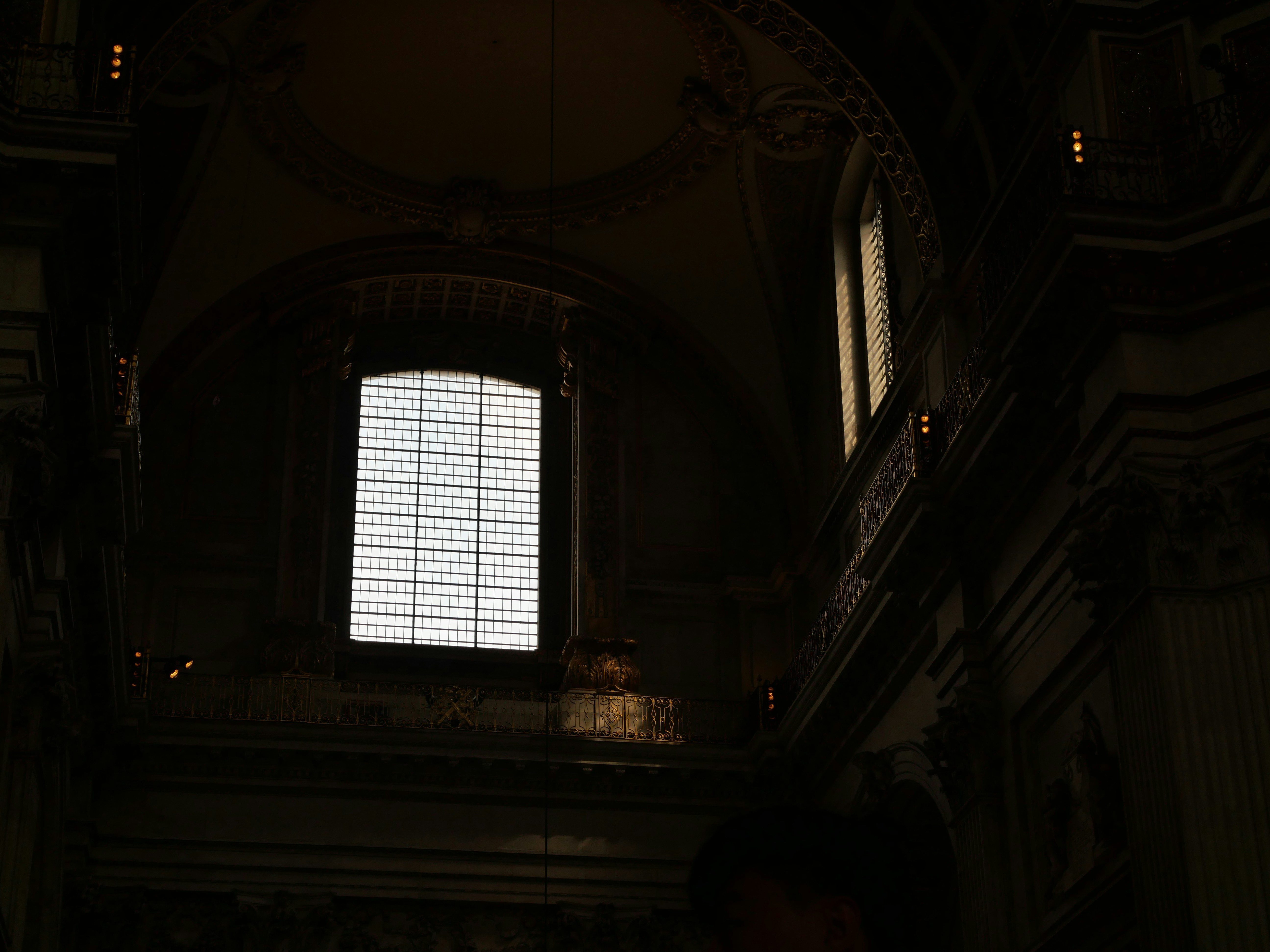 Interior window reveals light in a dark space.