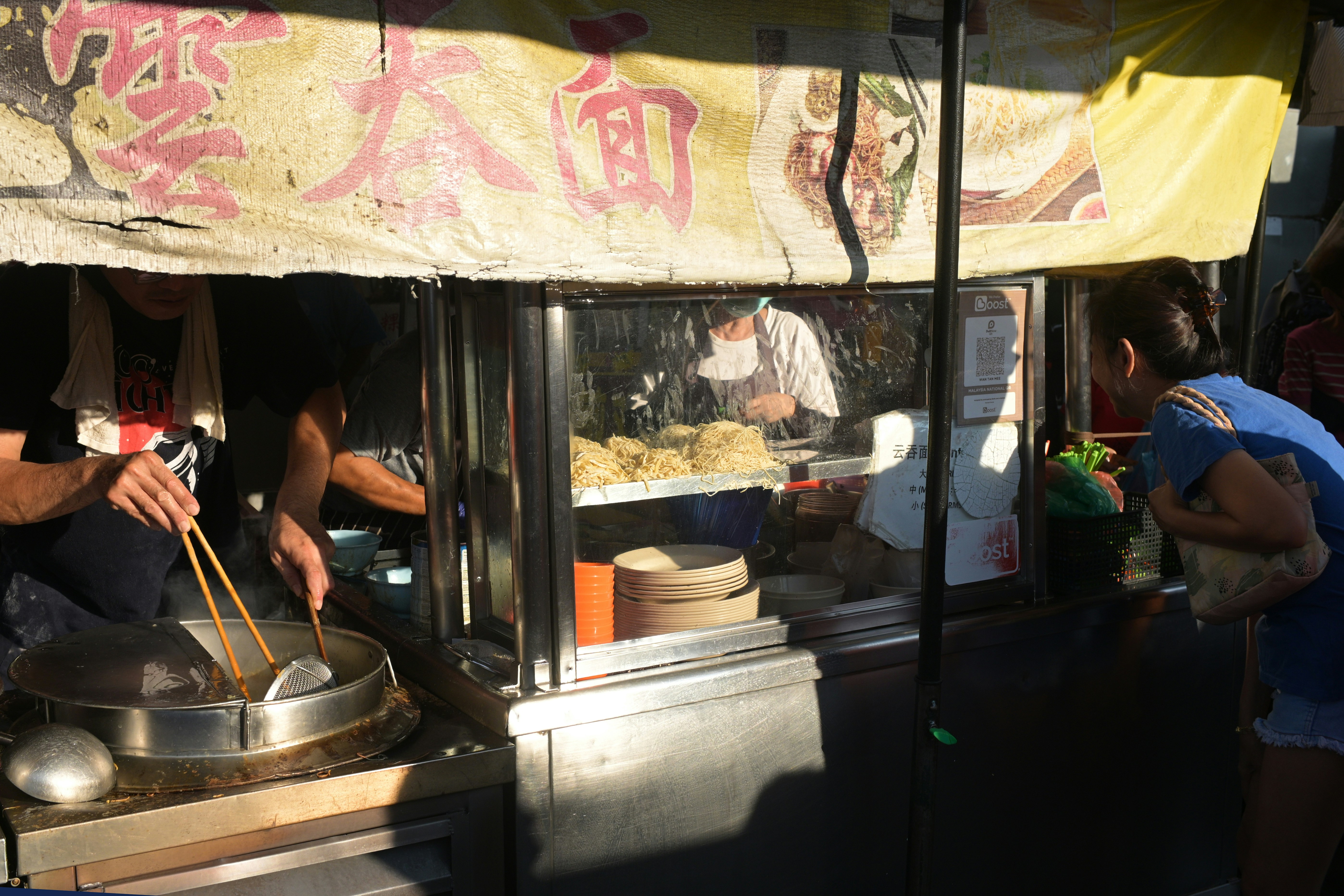 Street food vendor prepares food for customers.