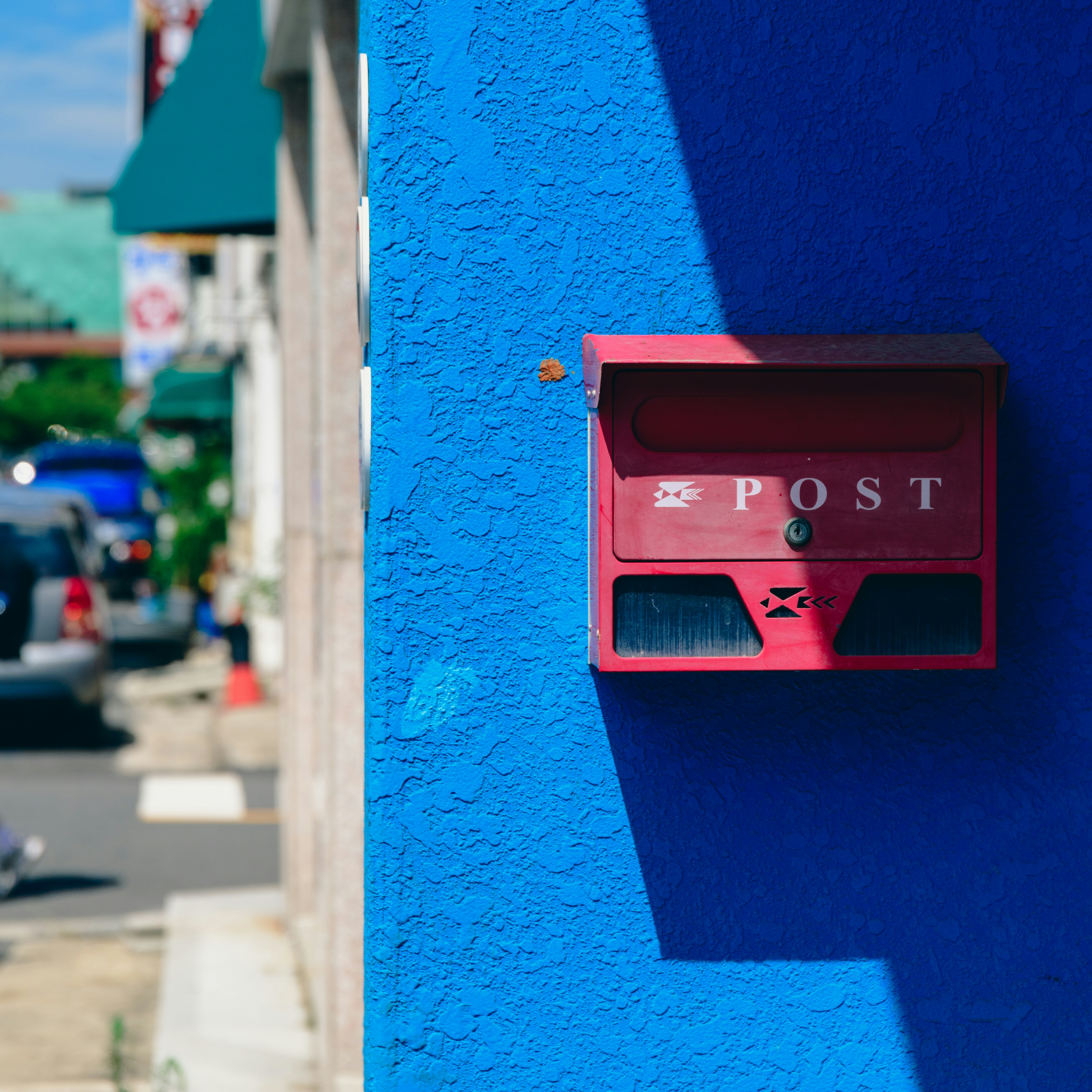 Crimson Mailbox Against a Vibrant Canvas