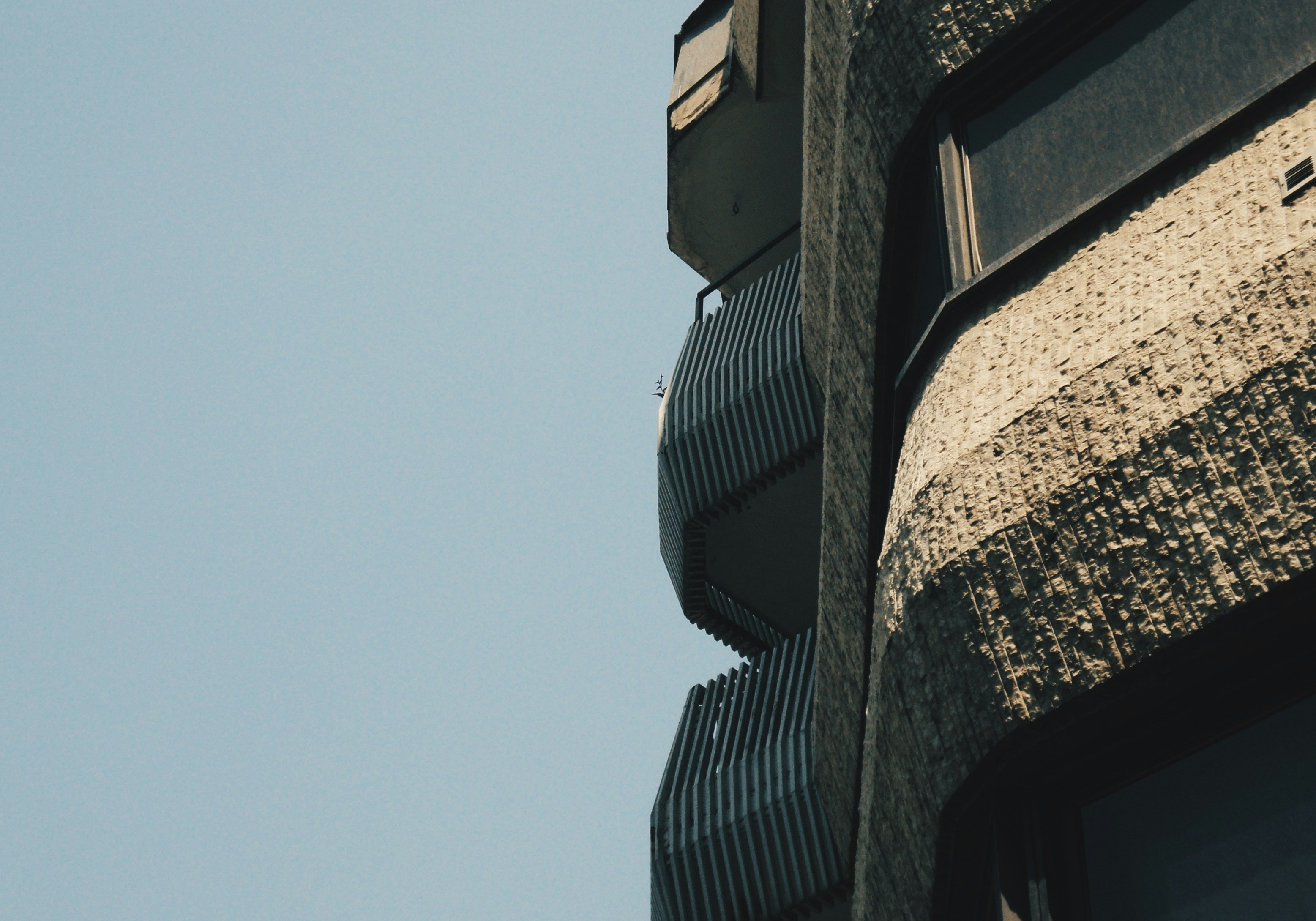 Beautifully brutal. | A modern building reaches up into the sky.