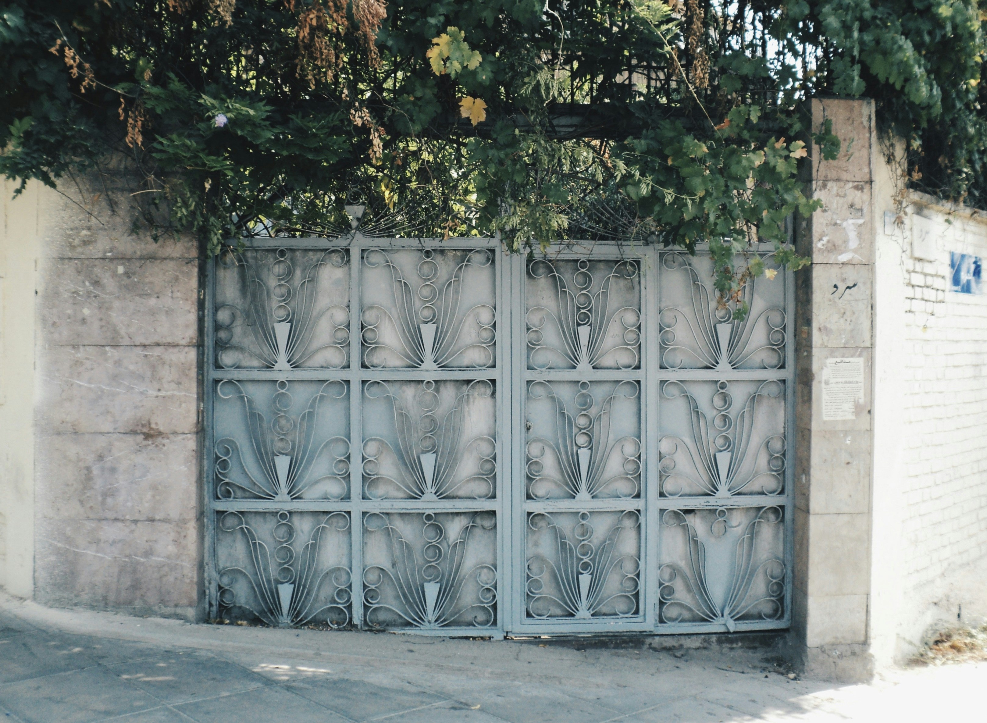 I wonder what lies behind. | Closed metal gates lead to a property.