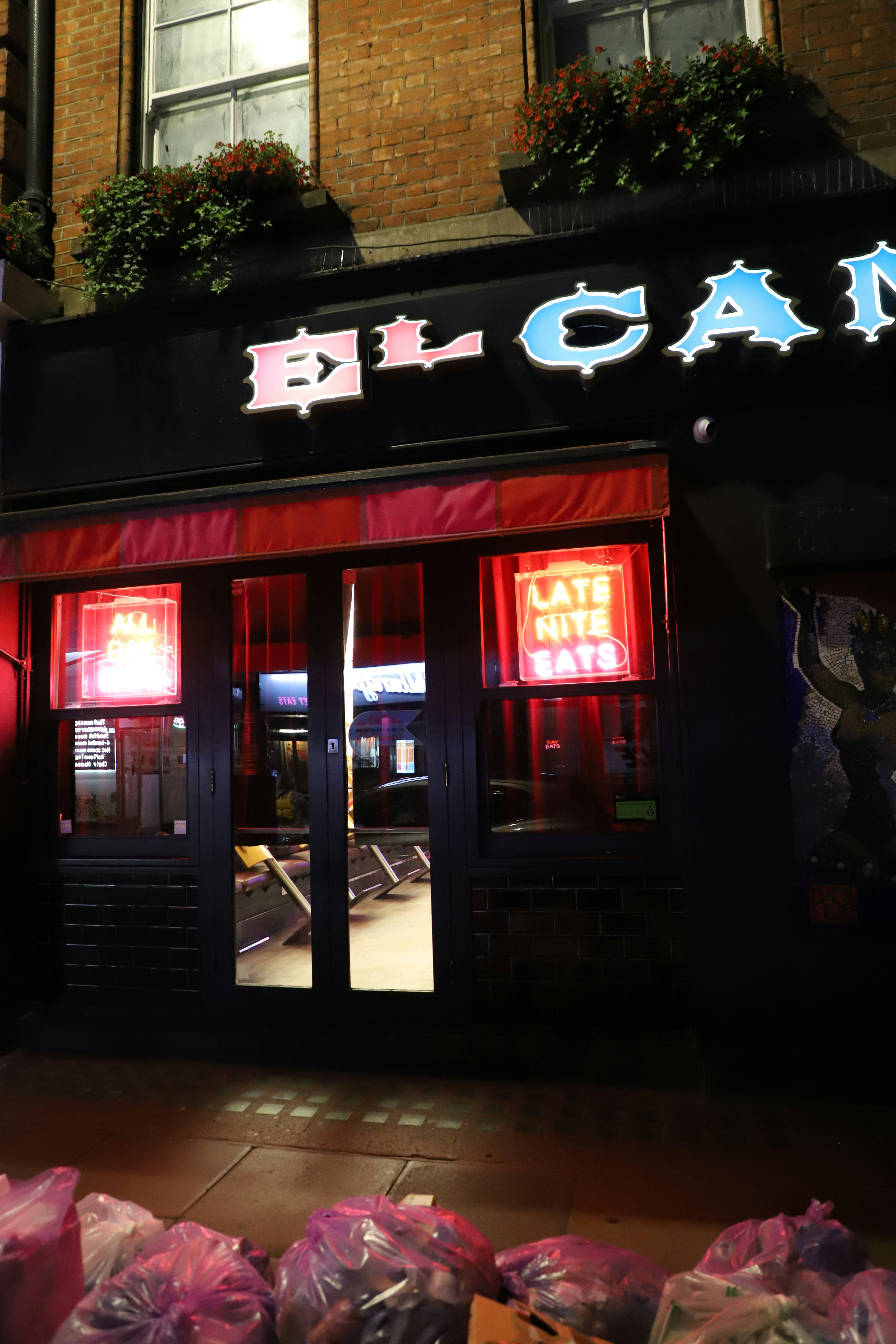 Soho, London | A bar named "el cant" illuminated at night.