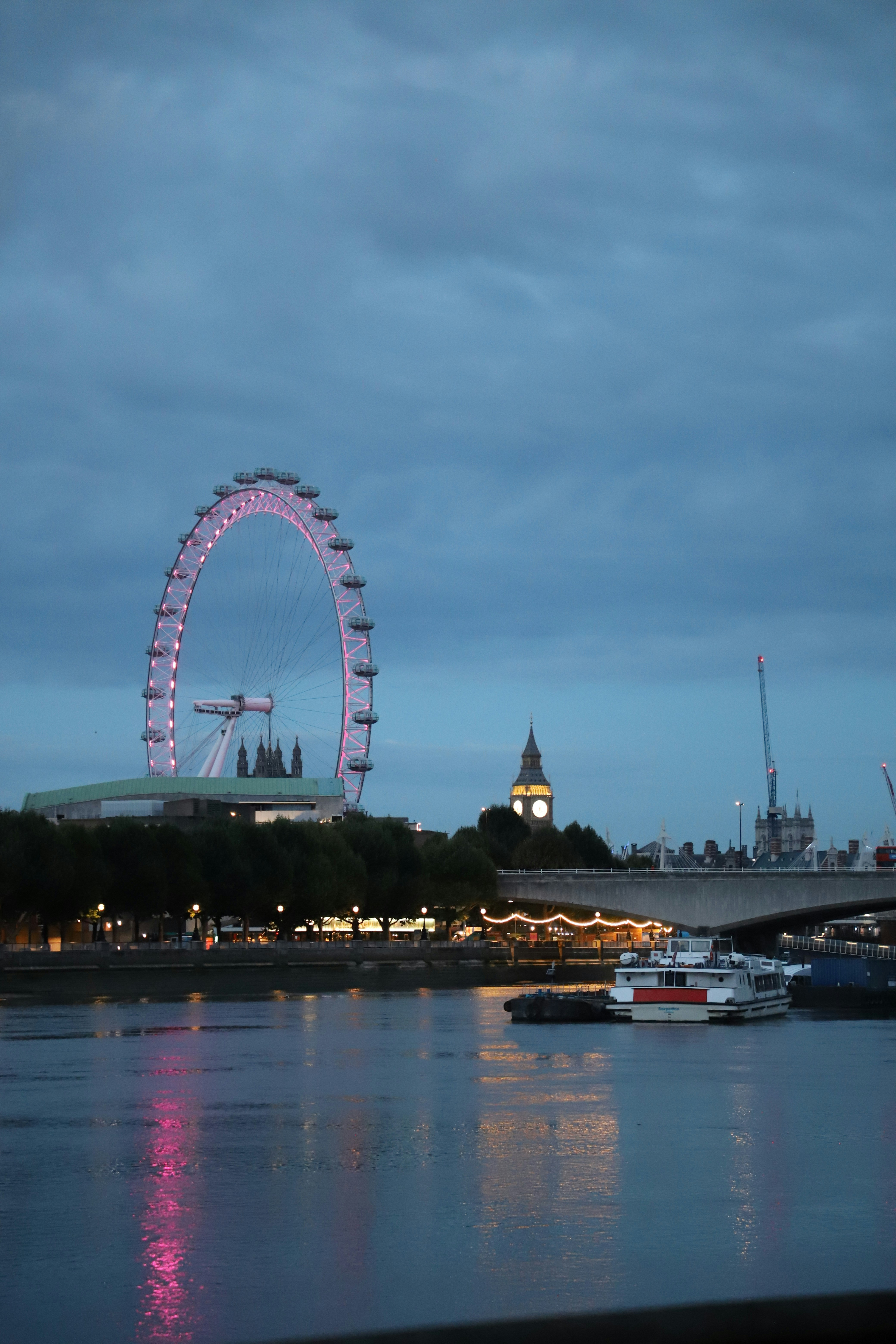 London pre dawn | The london eye glows over the river thames at dusk.