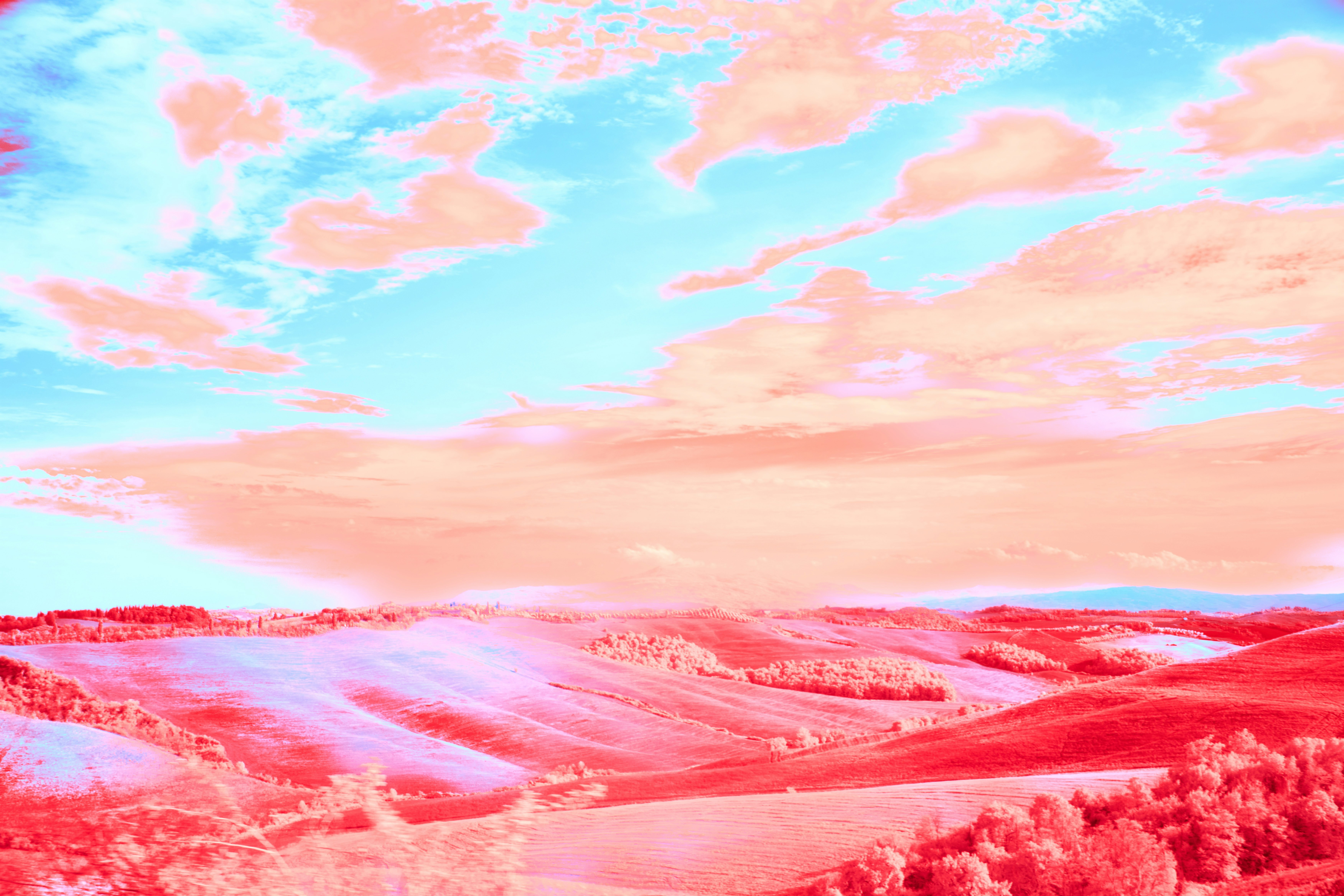A dreamy landscape of rolling red hills.
