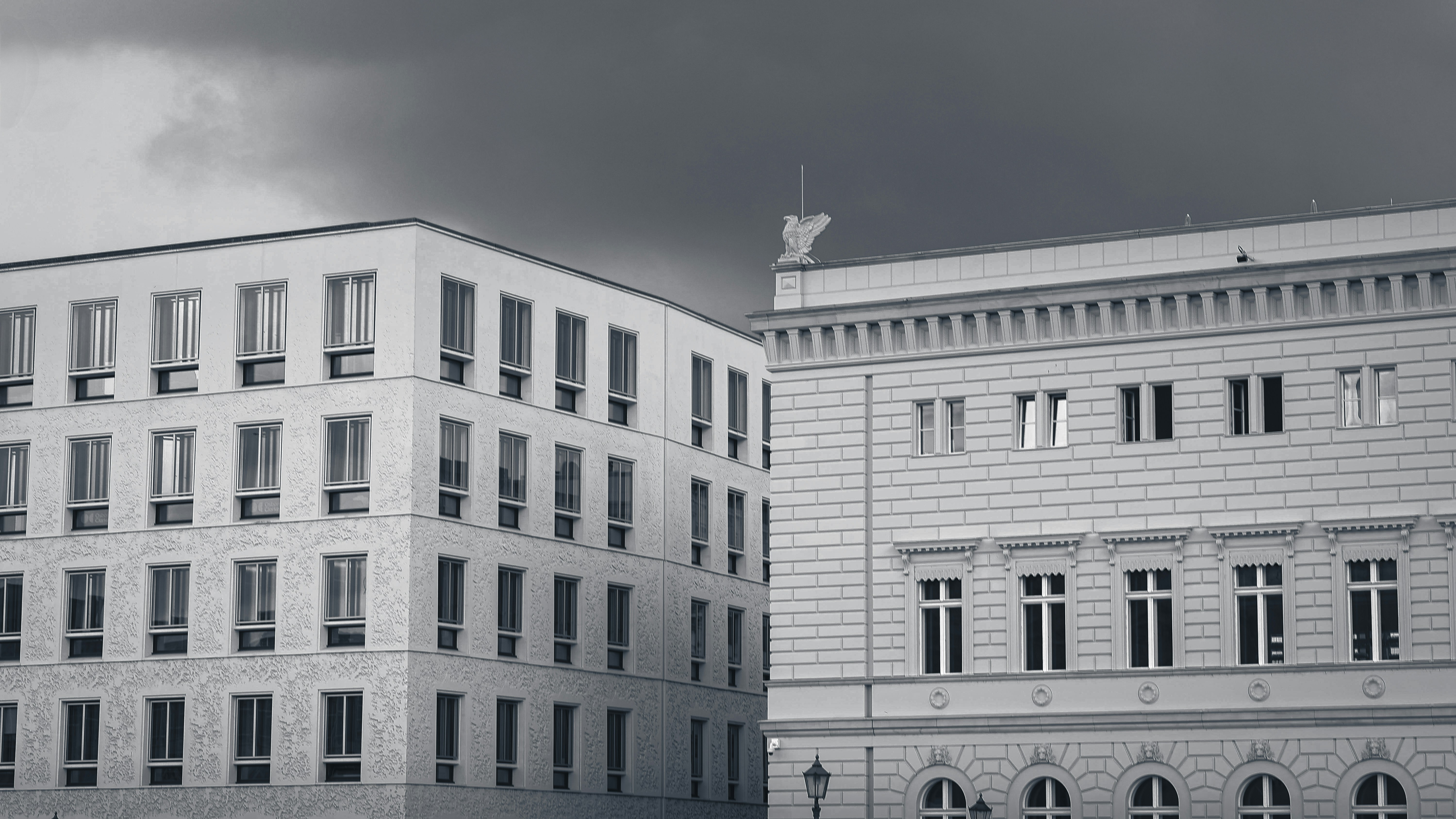 Buildings stand under a cloudy, gray sky.