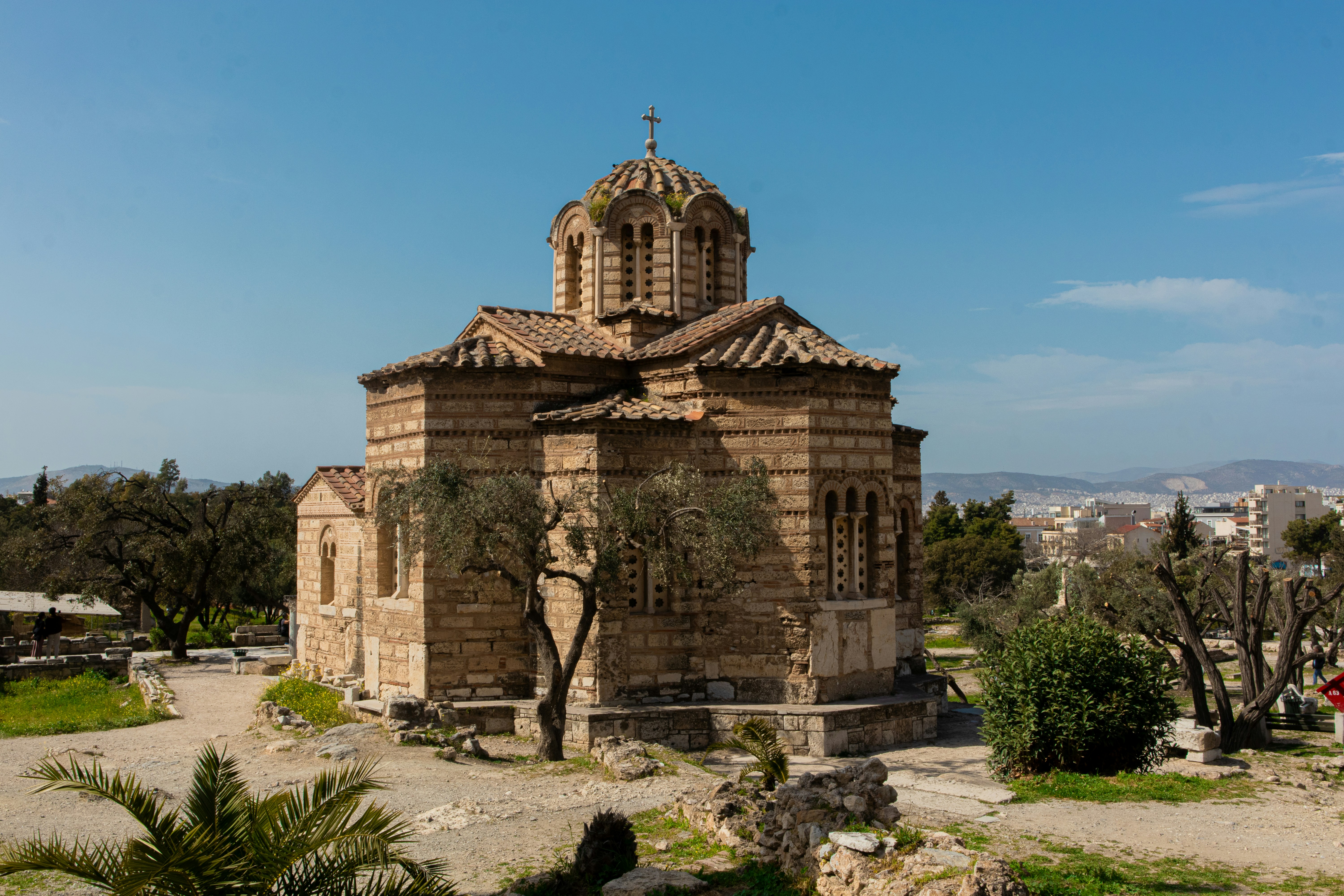 Church of the Holy Apostles | A stone church stands against a bright blue sky.