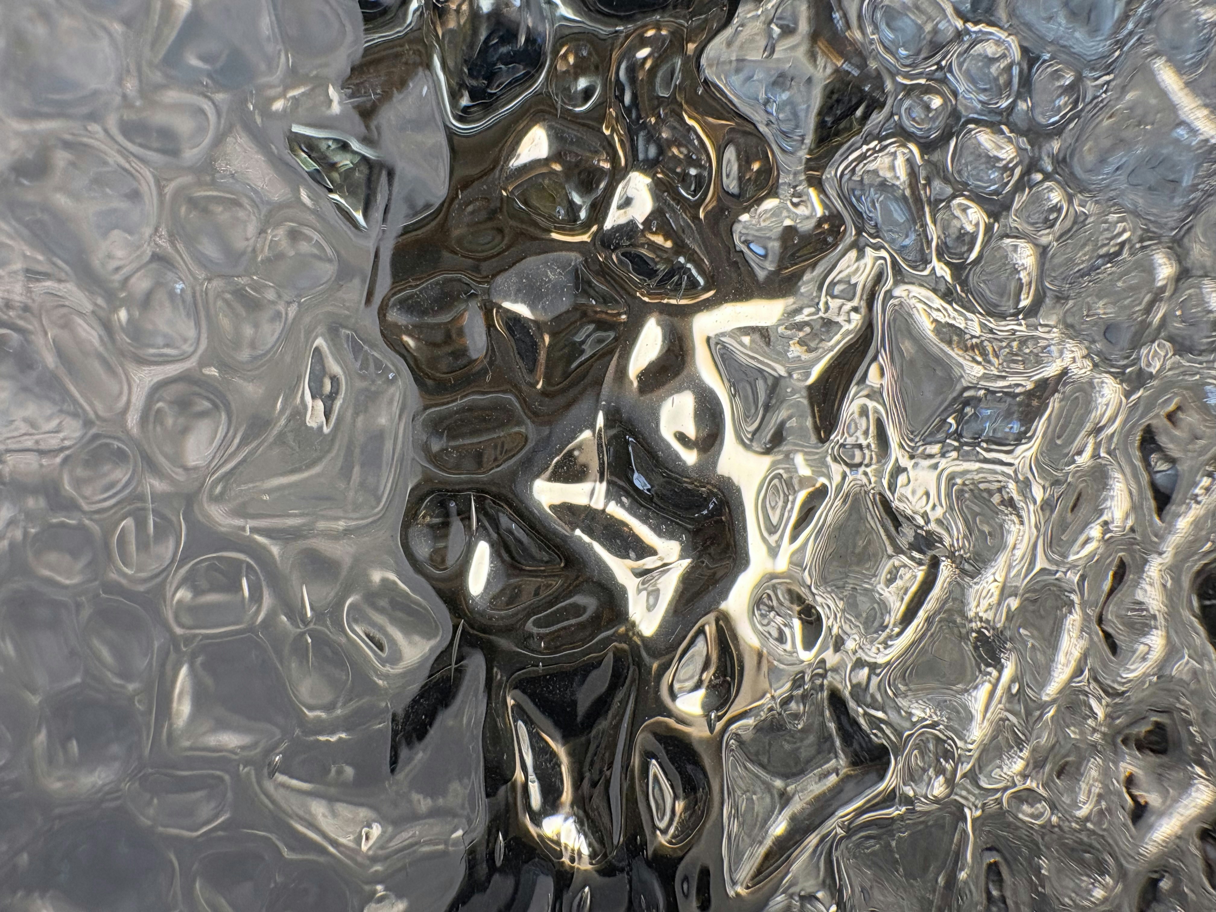 Reflective, textured glass creates an abstract design.