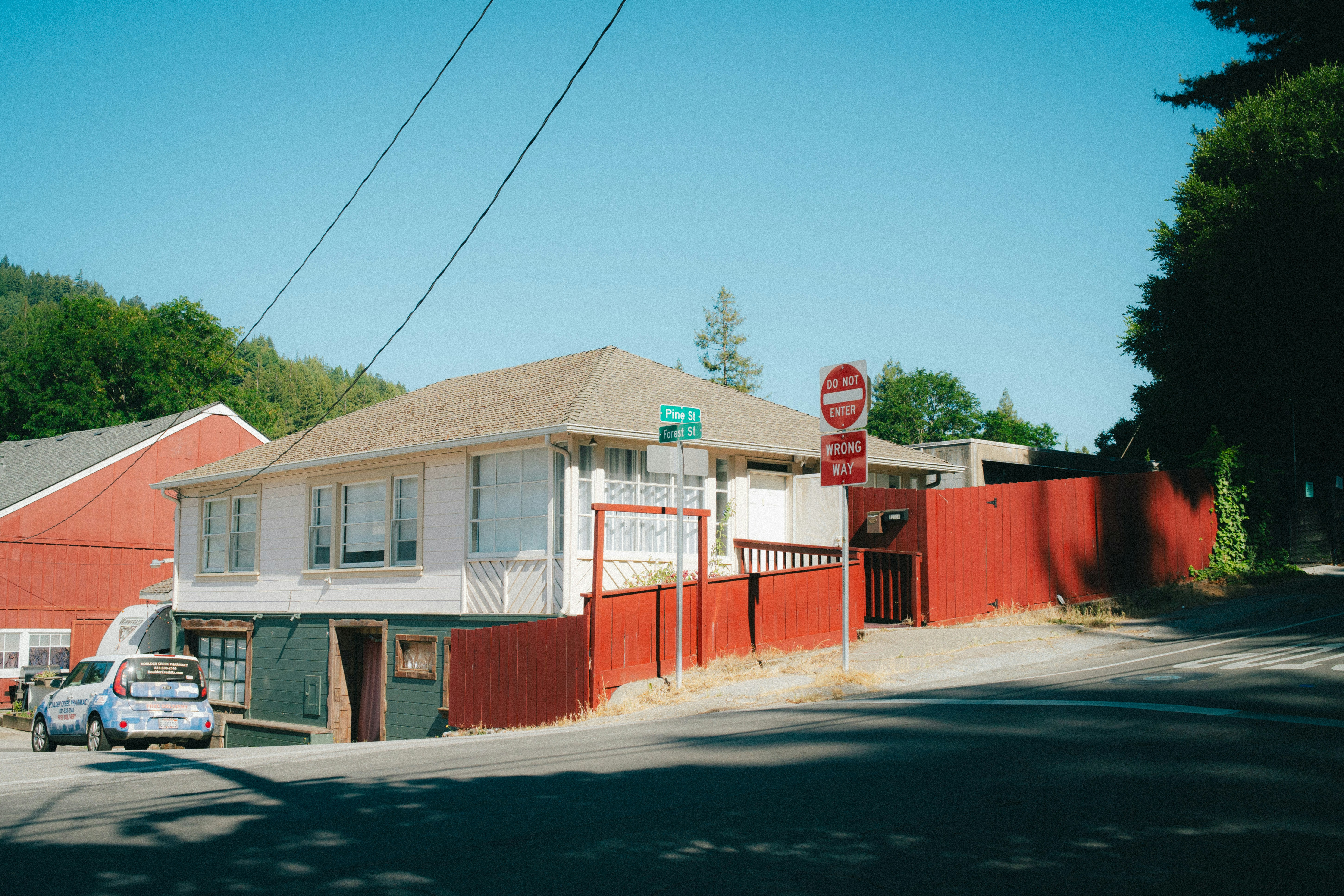 A building with a red wall and "do not enter" sign.