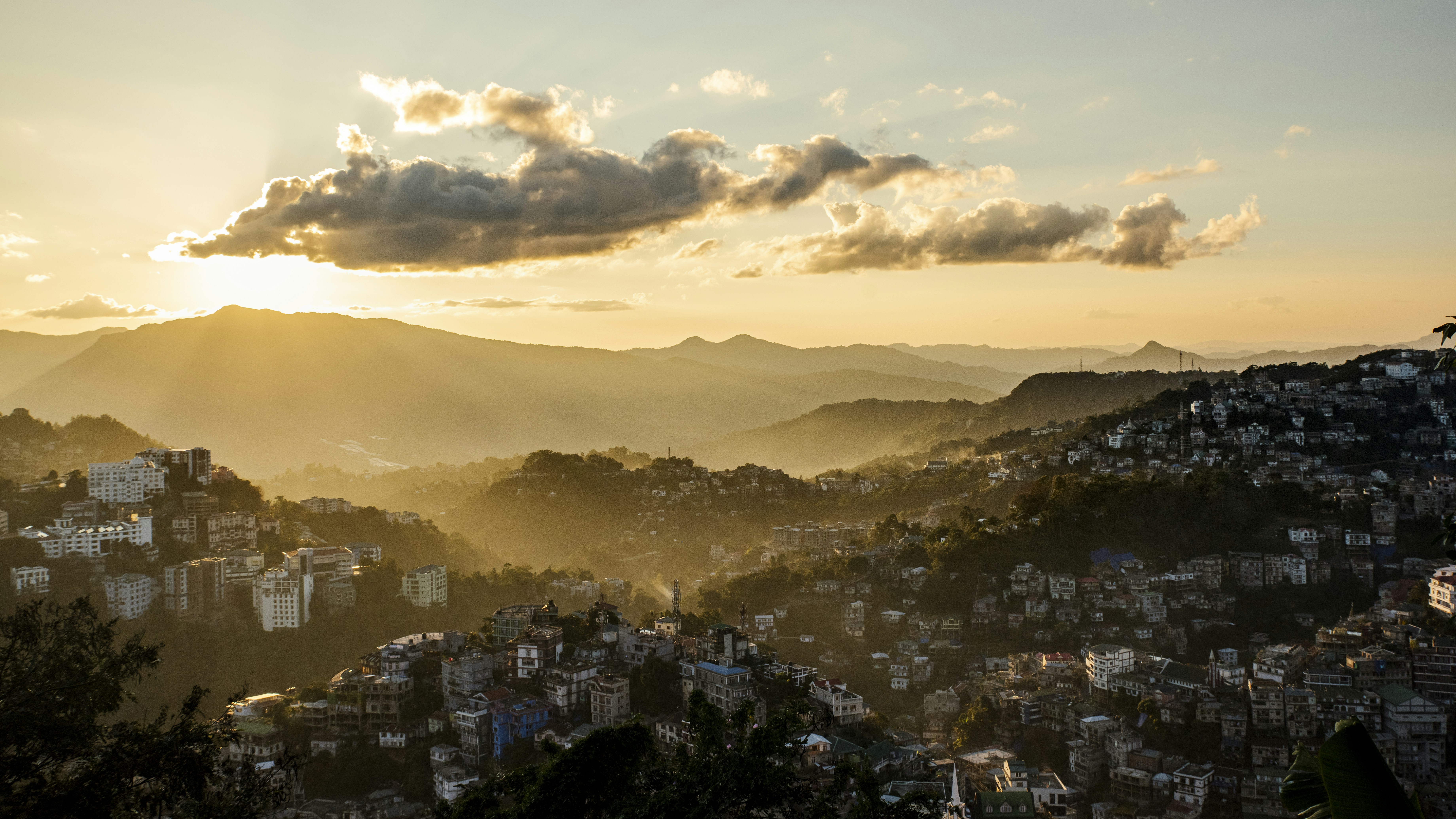 Golden sunset illuminates a mountain town.