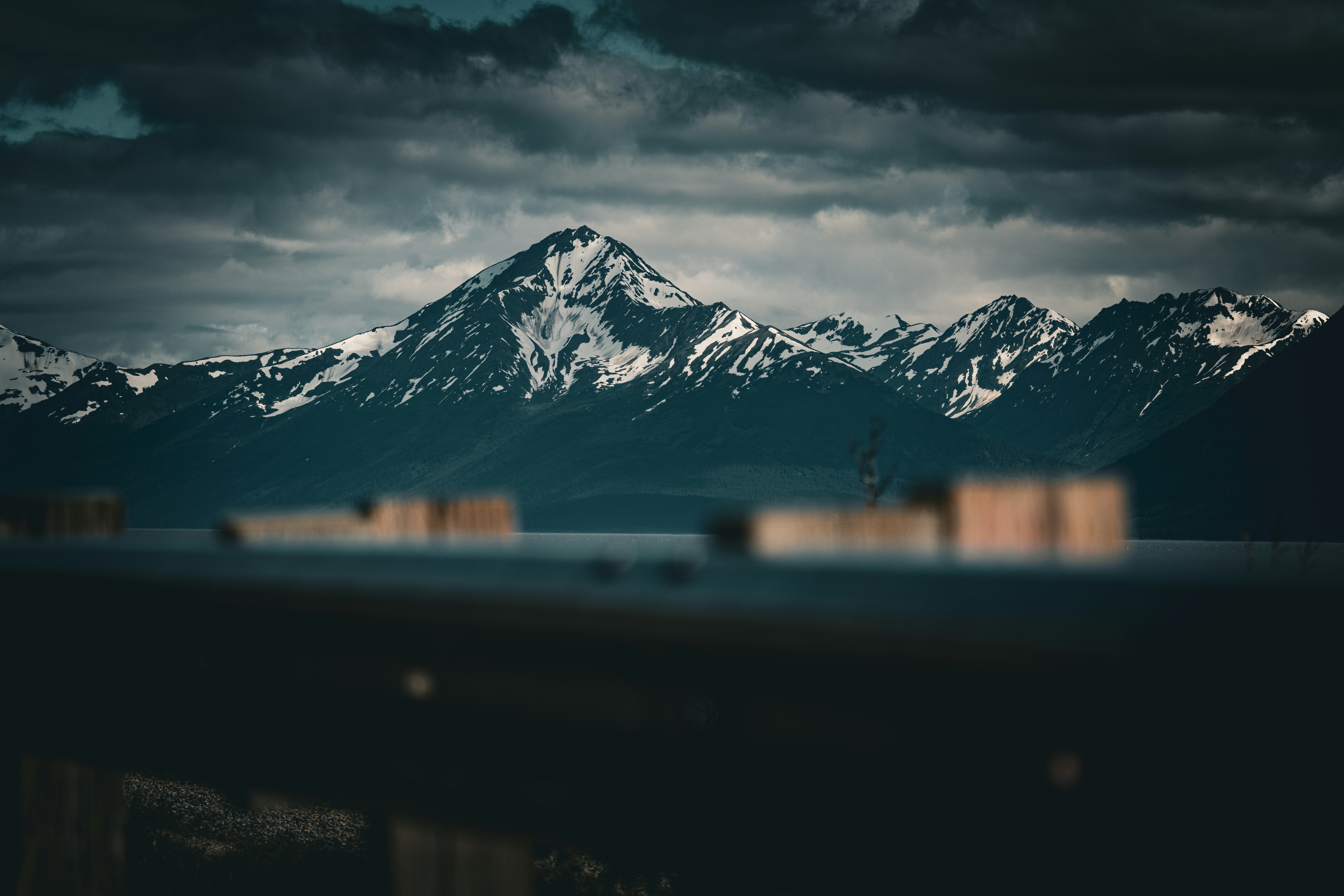 Snow-capped mountains rise beneath a cloudy sky.