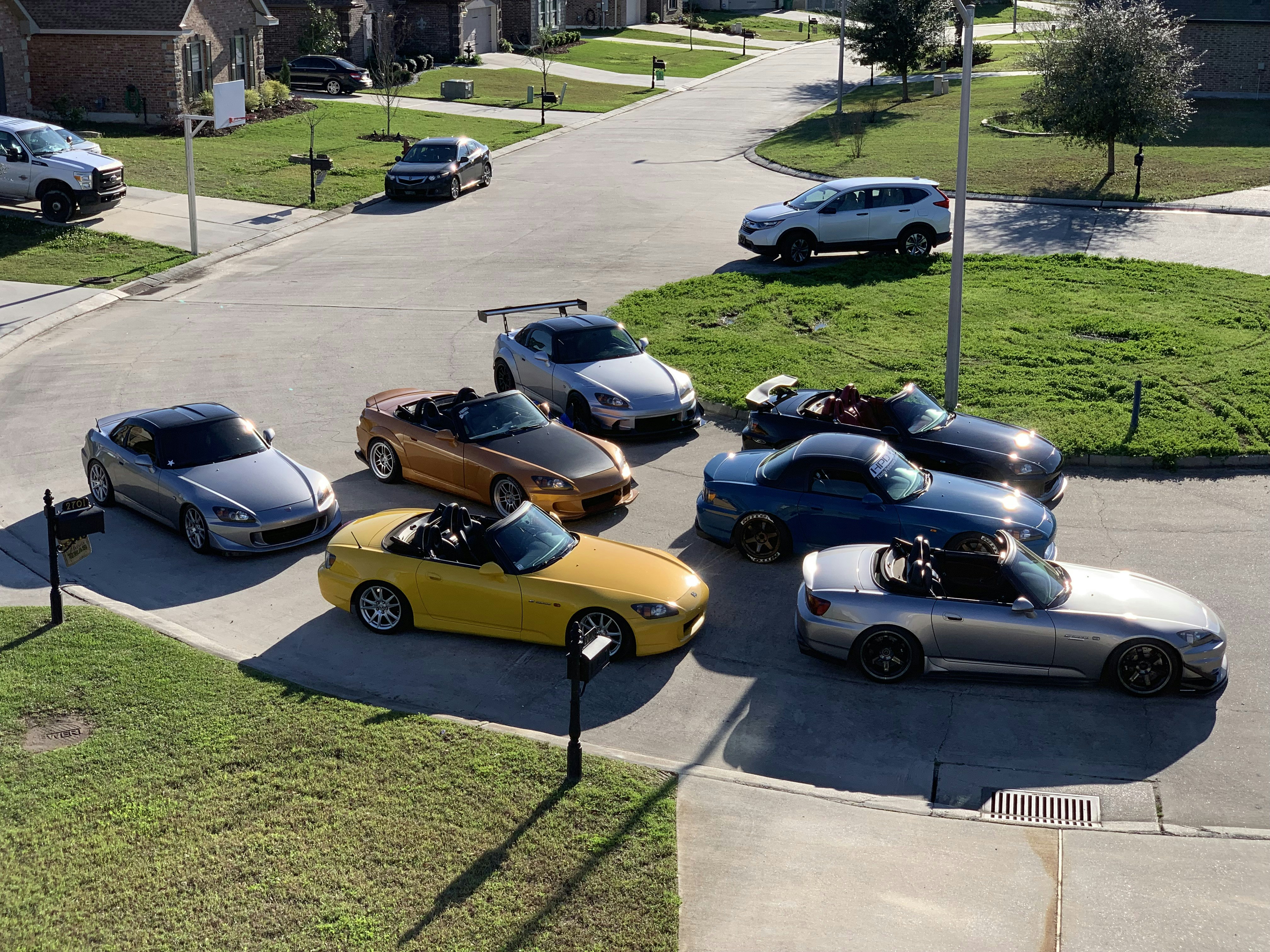 A group of sports cars parked on a street.