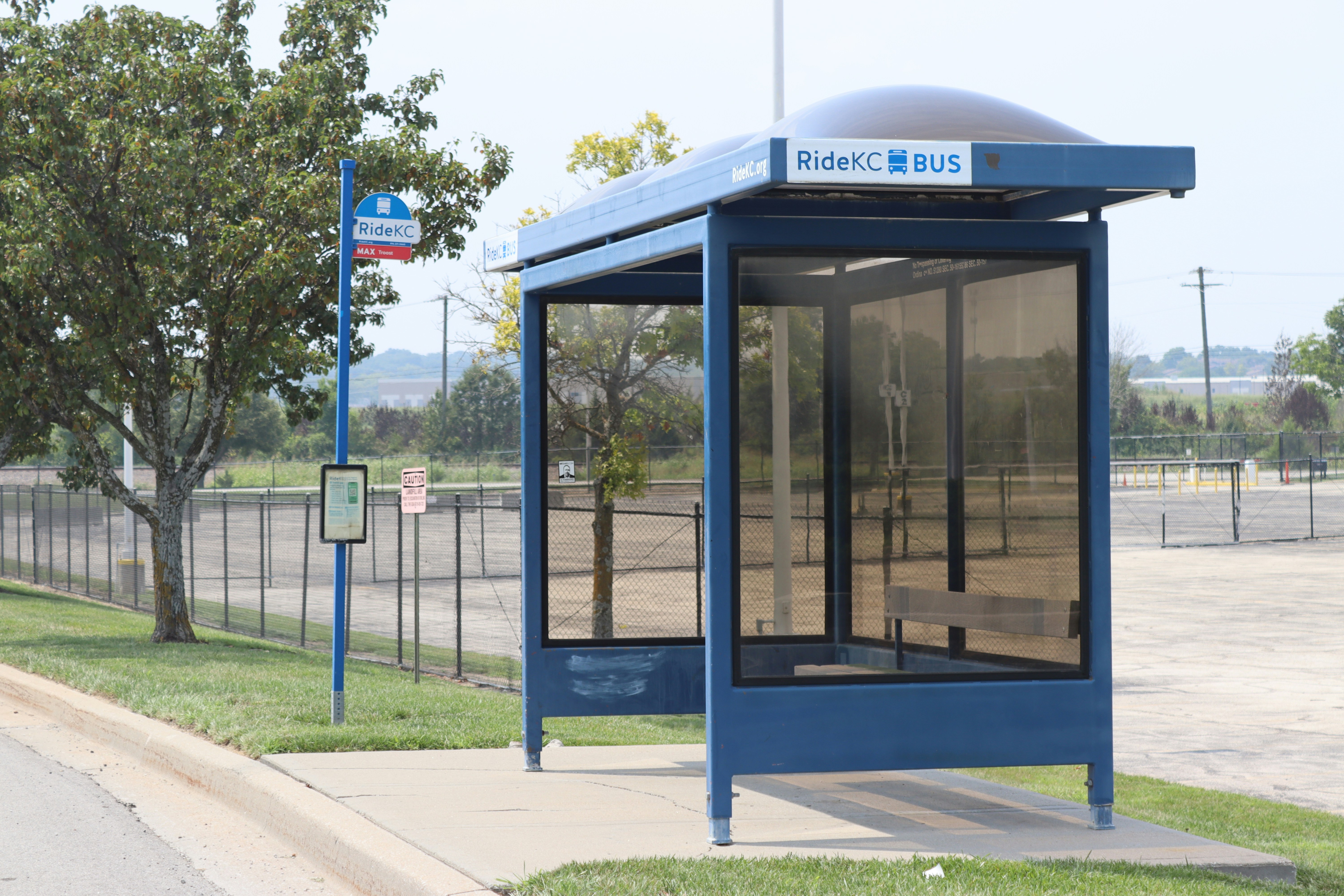 Bus Stop in Kansas City waiting to be used. | A blue bus shelter awaits passengers.