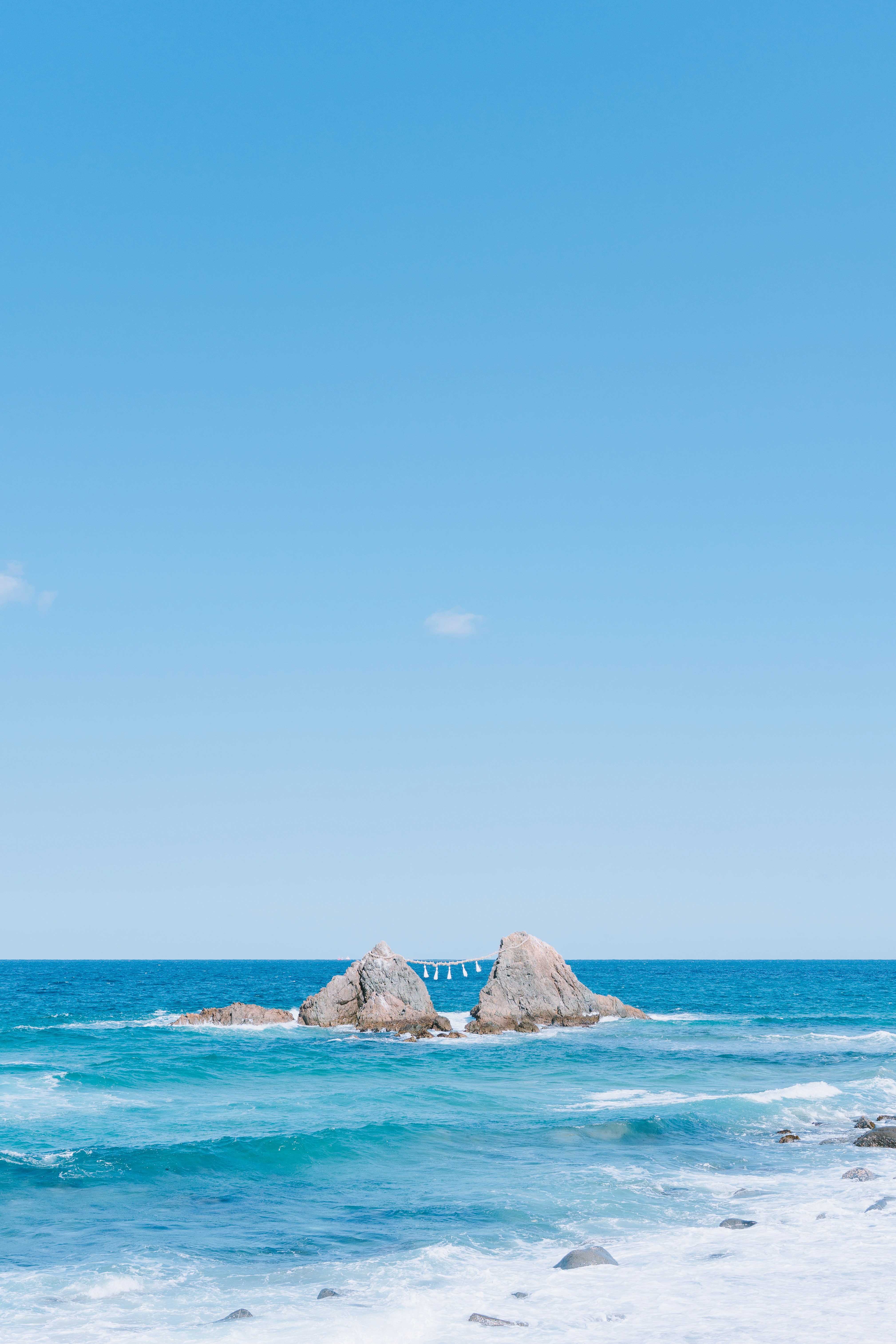Isolated Rock Outcrop in a Calm Blue Sea