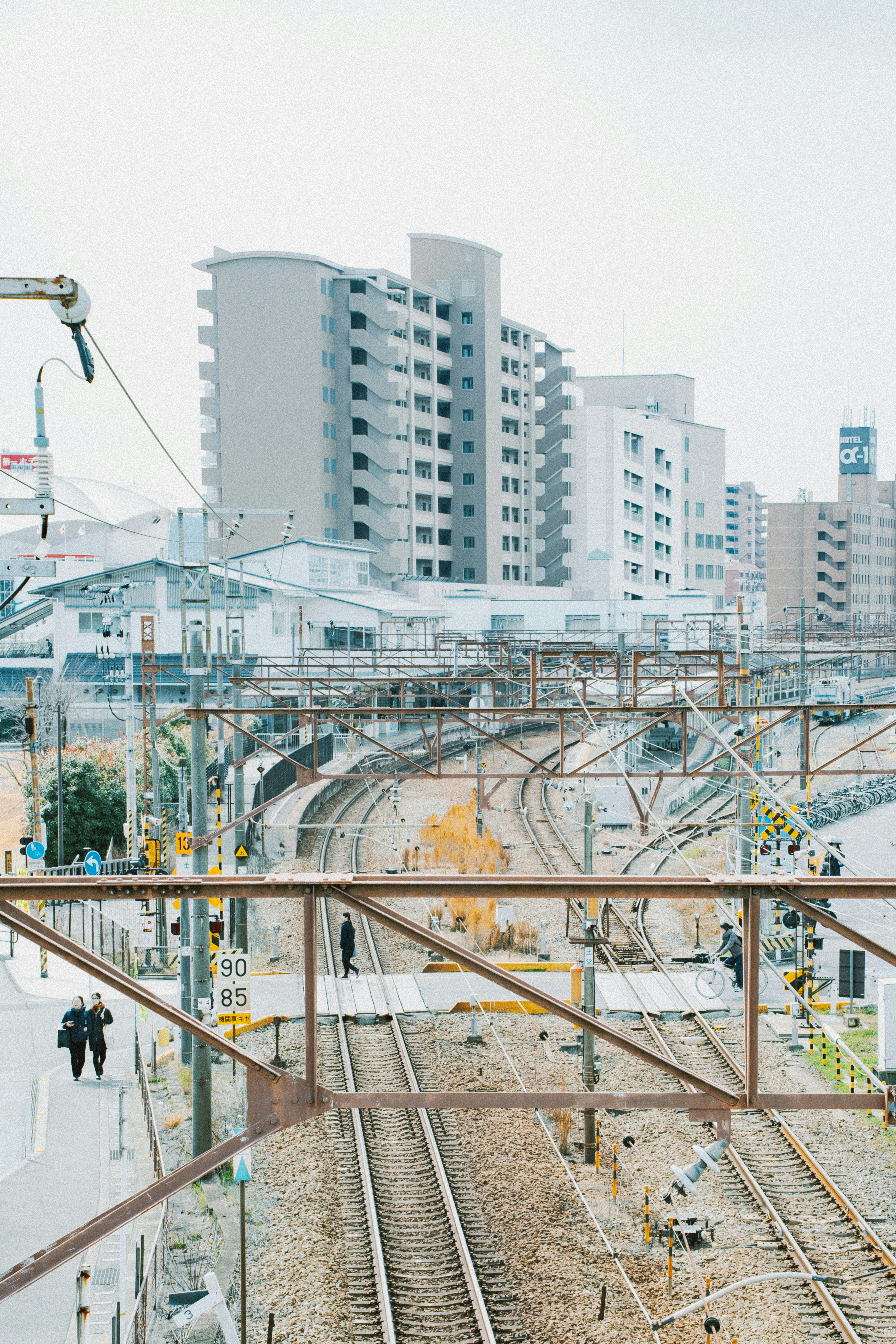 Train tracks lead into a cityscape with buildings.