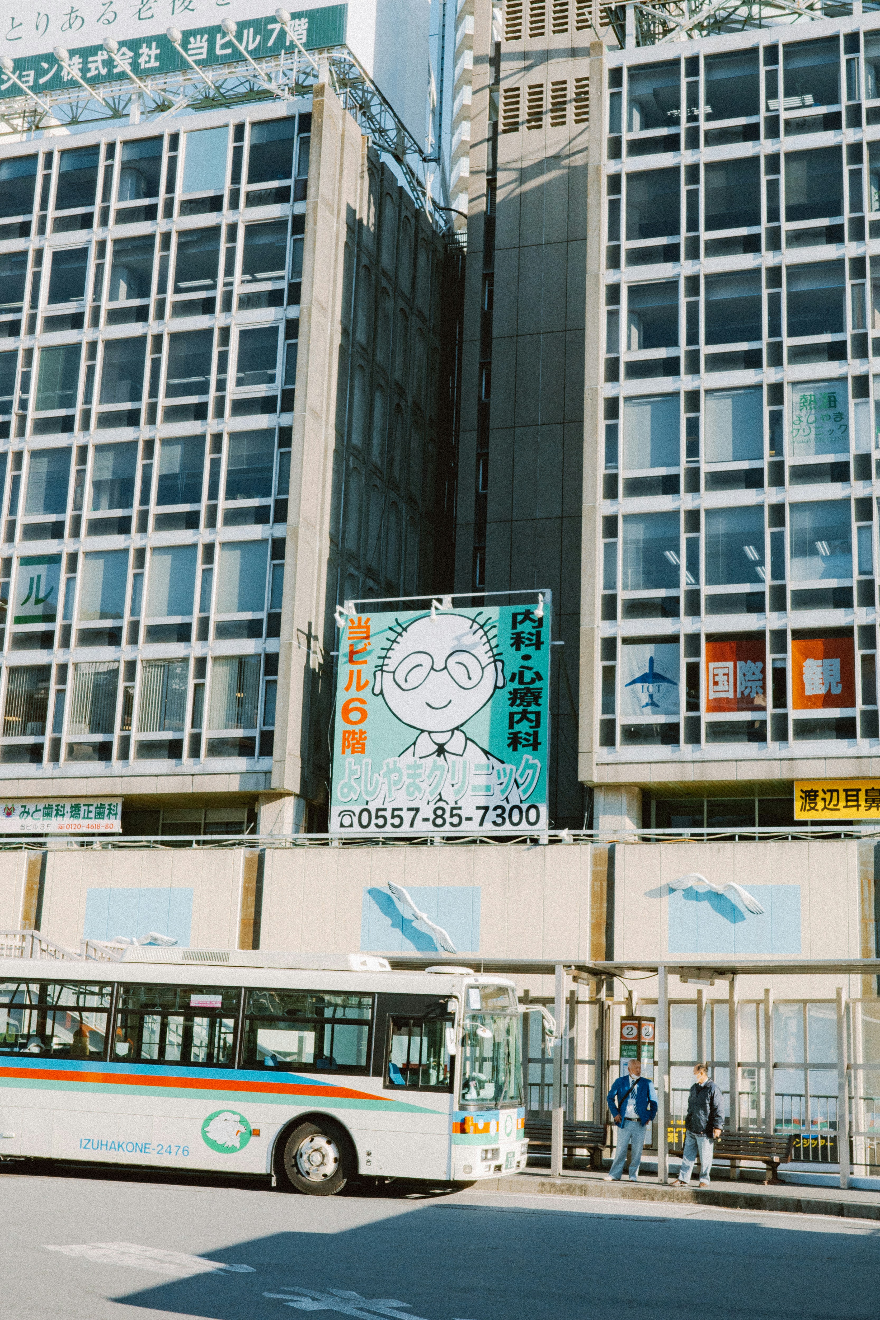 Buildings and a bus in a japanese city.