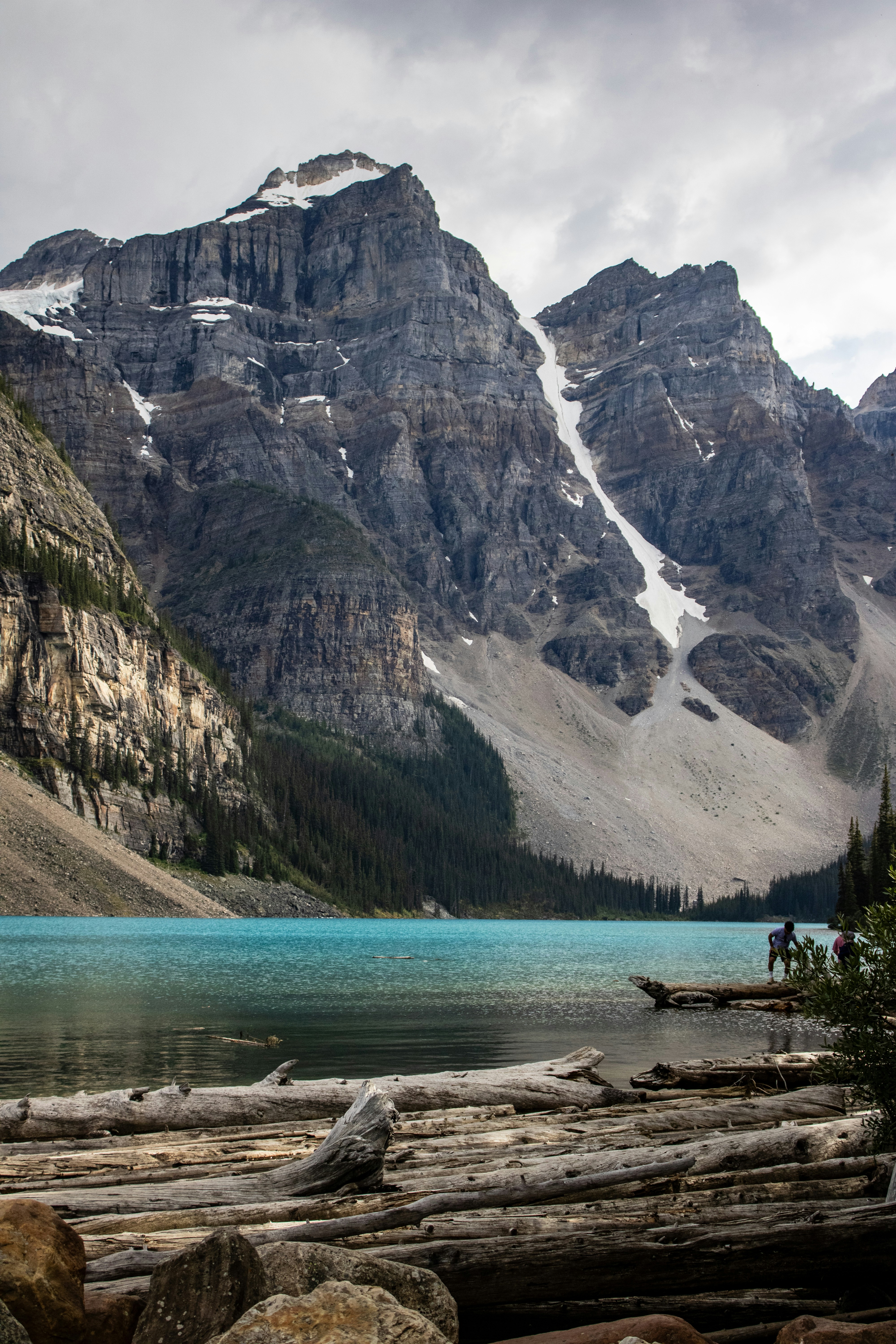 Majestic mountains tower over a stunning, turquoise lake.