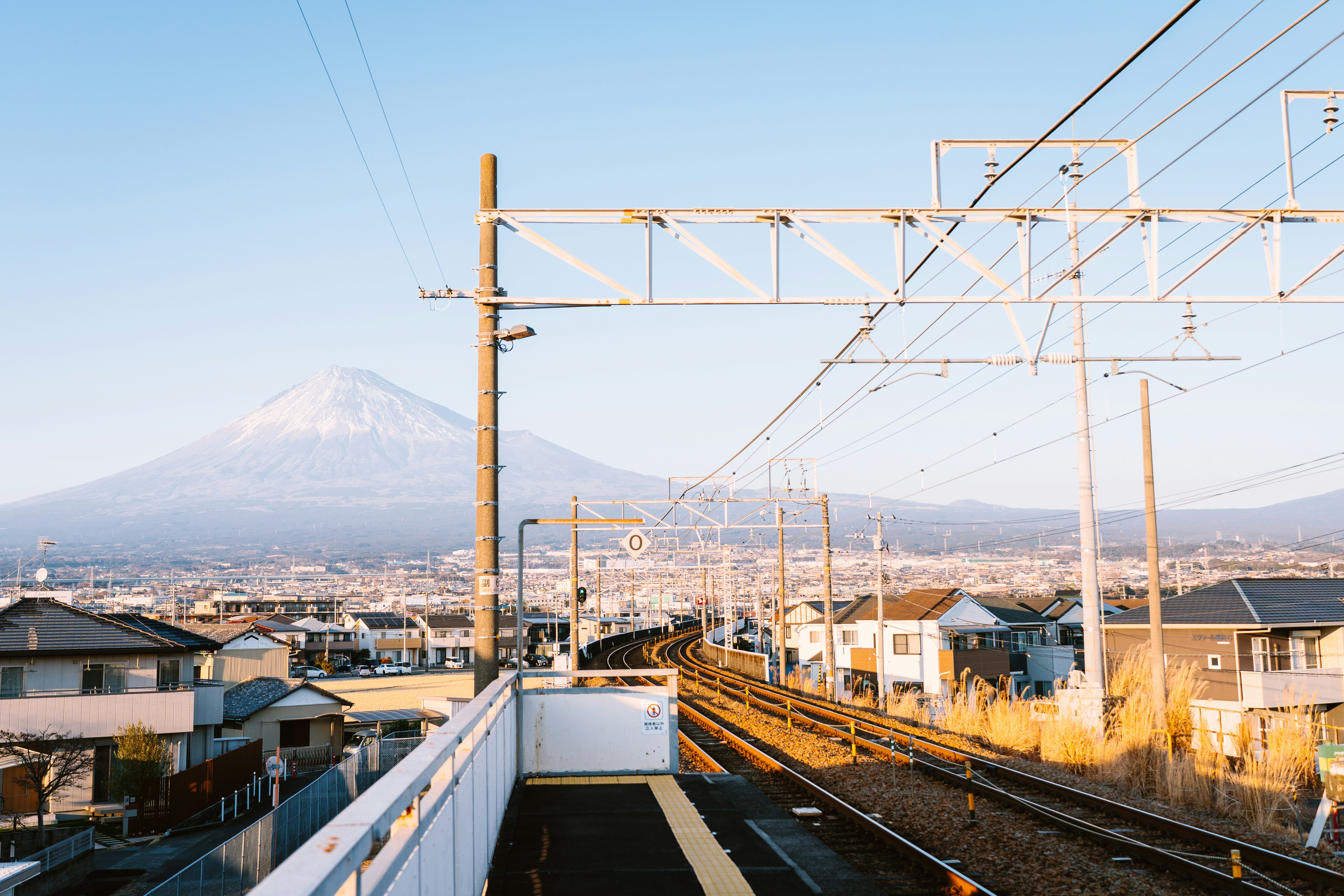 Tracks Toward Fuji's Snowcap: Dawn Light on a Suburban Rail Line