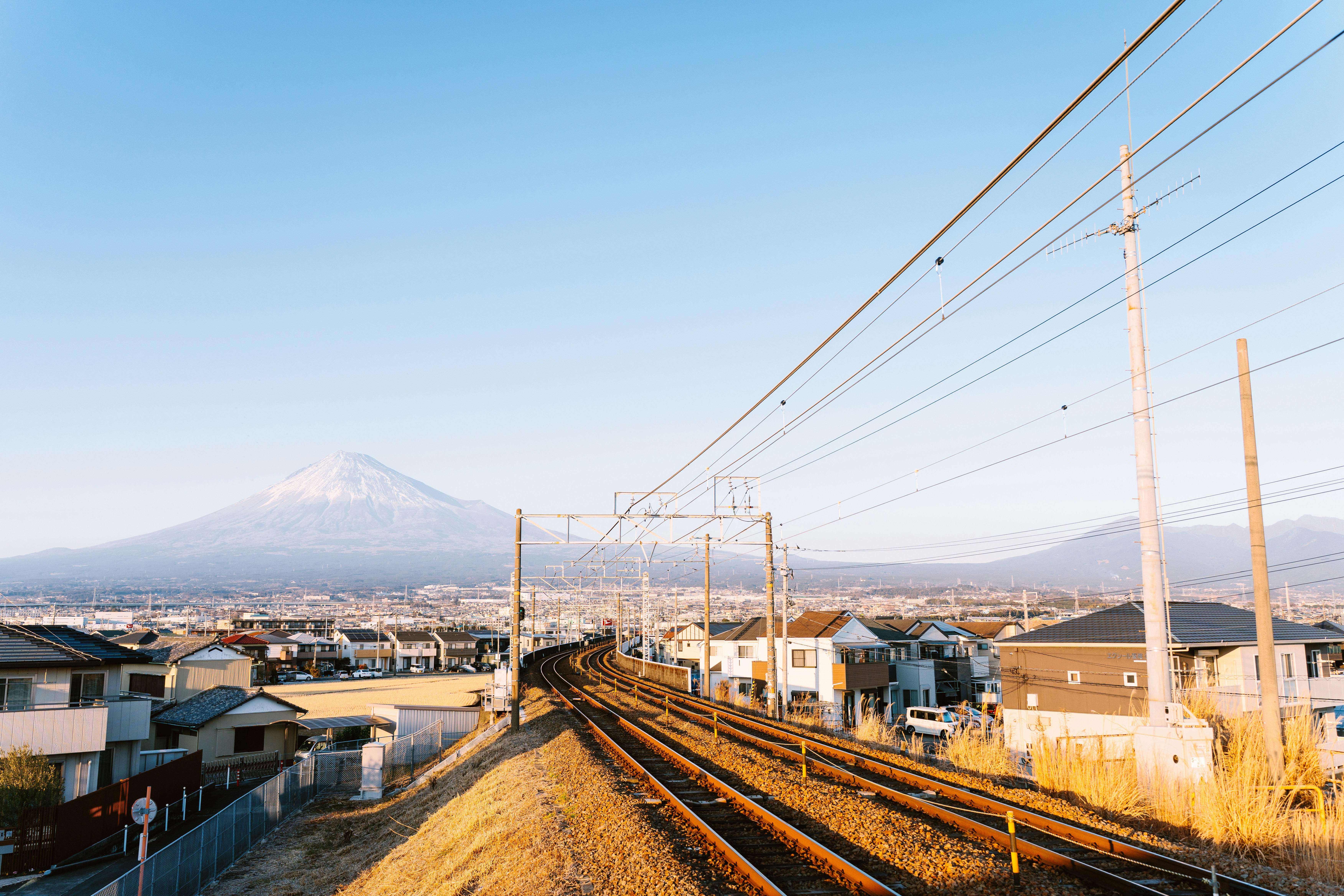 Railway Ribbon to a Snow-Capped Summit