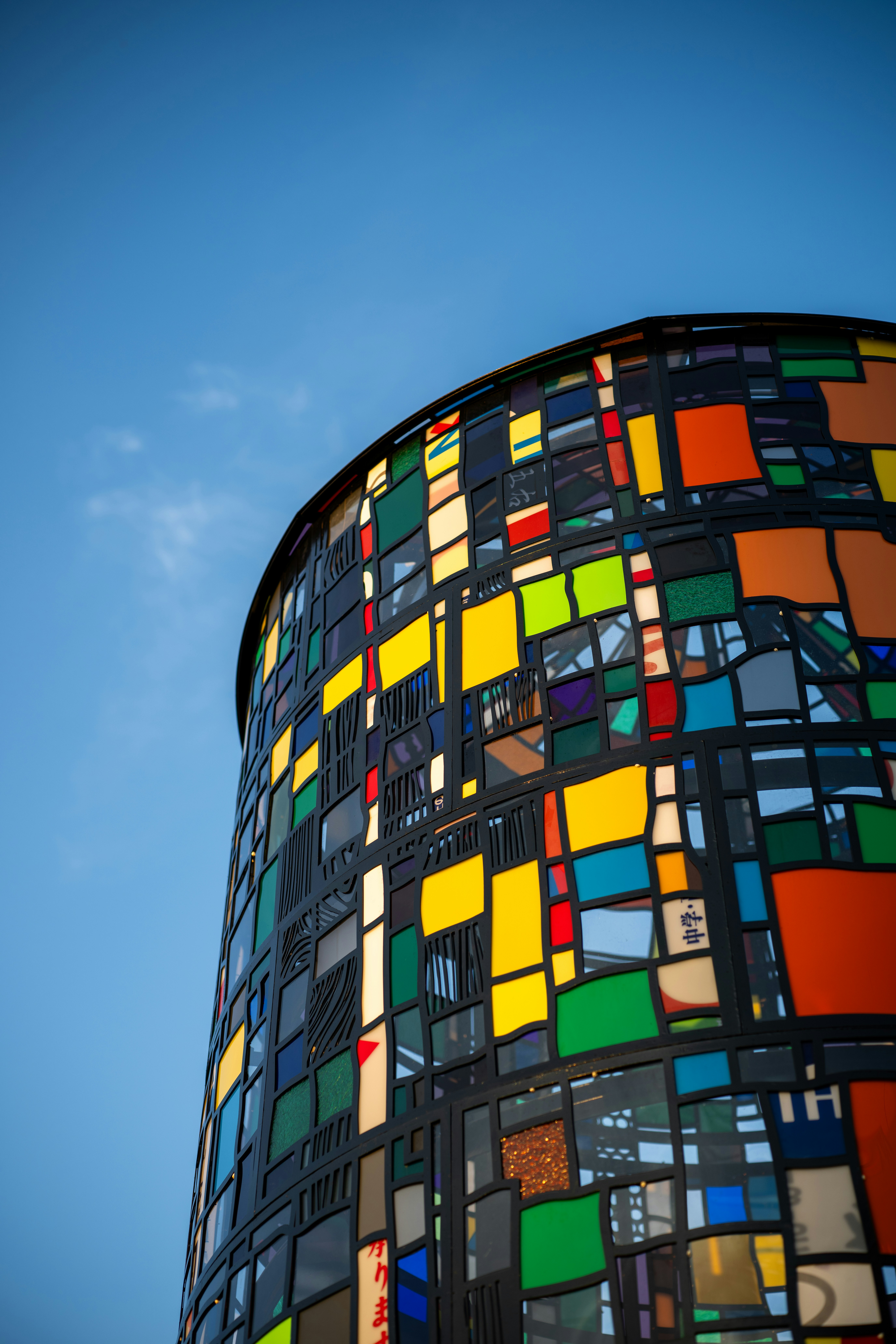 A Curved Mosaic: Colorful Glass Facade Bending with the Sky