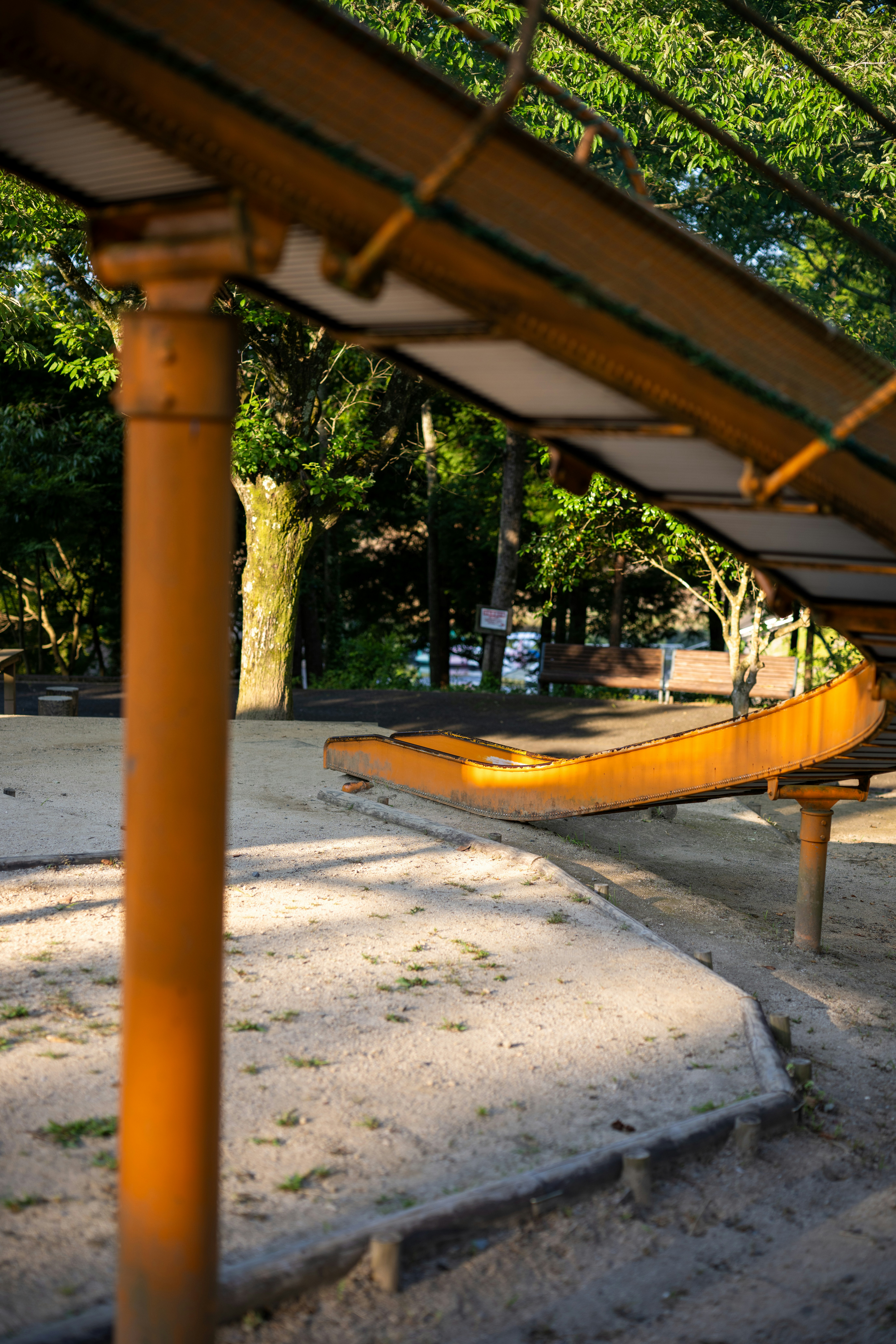 A park playground with an empty slide.