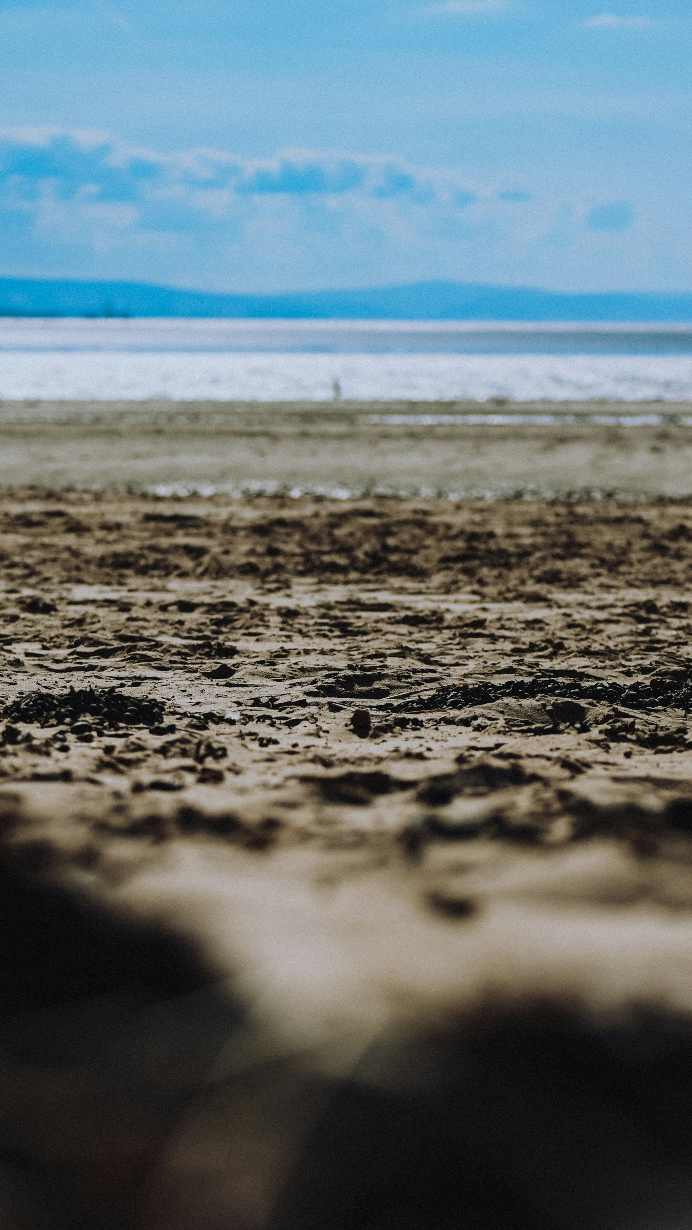The beach meets the ocean on a sunny day.
