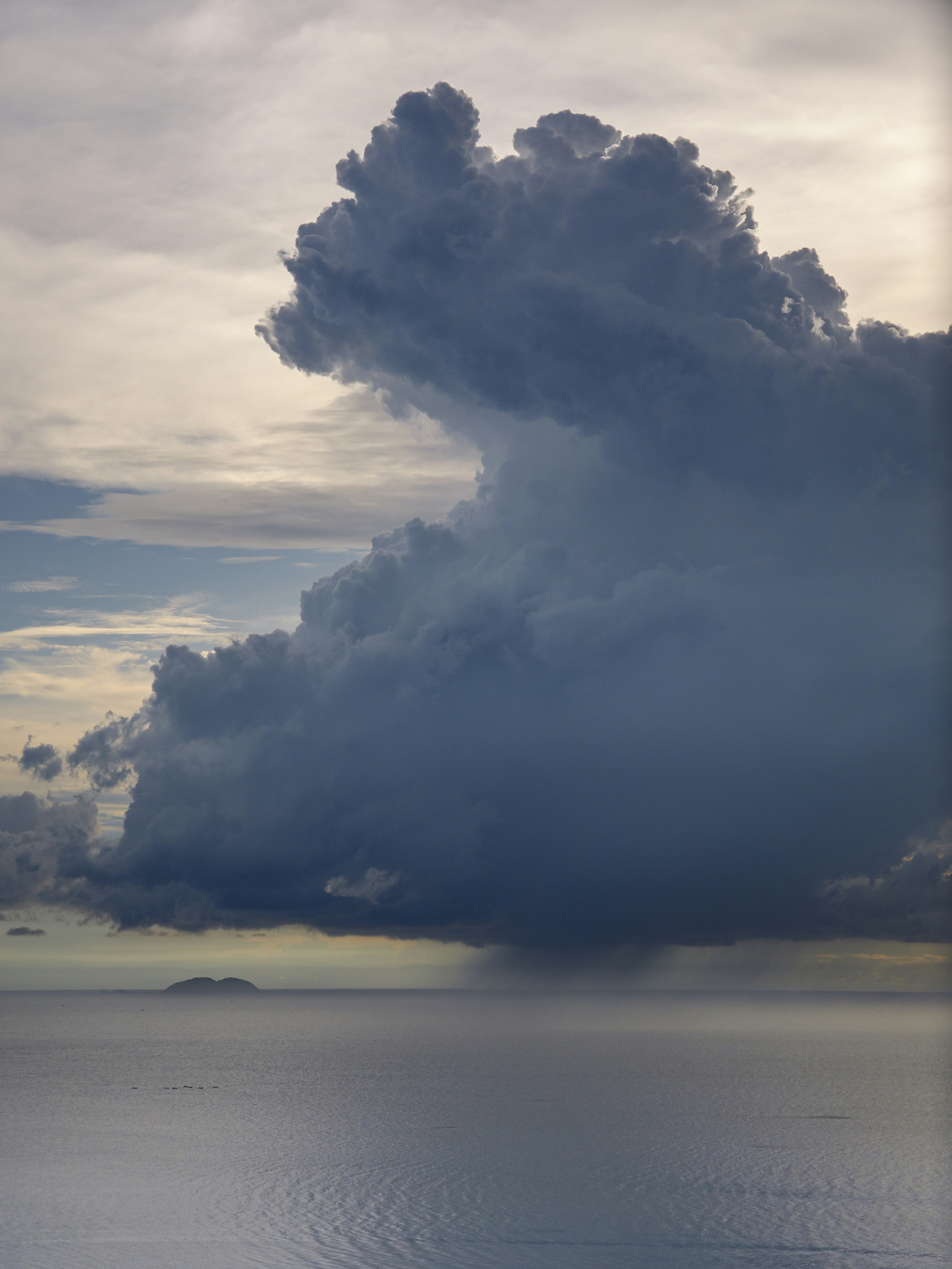 Dramatic cloud formation above the ocean.