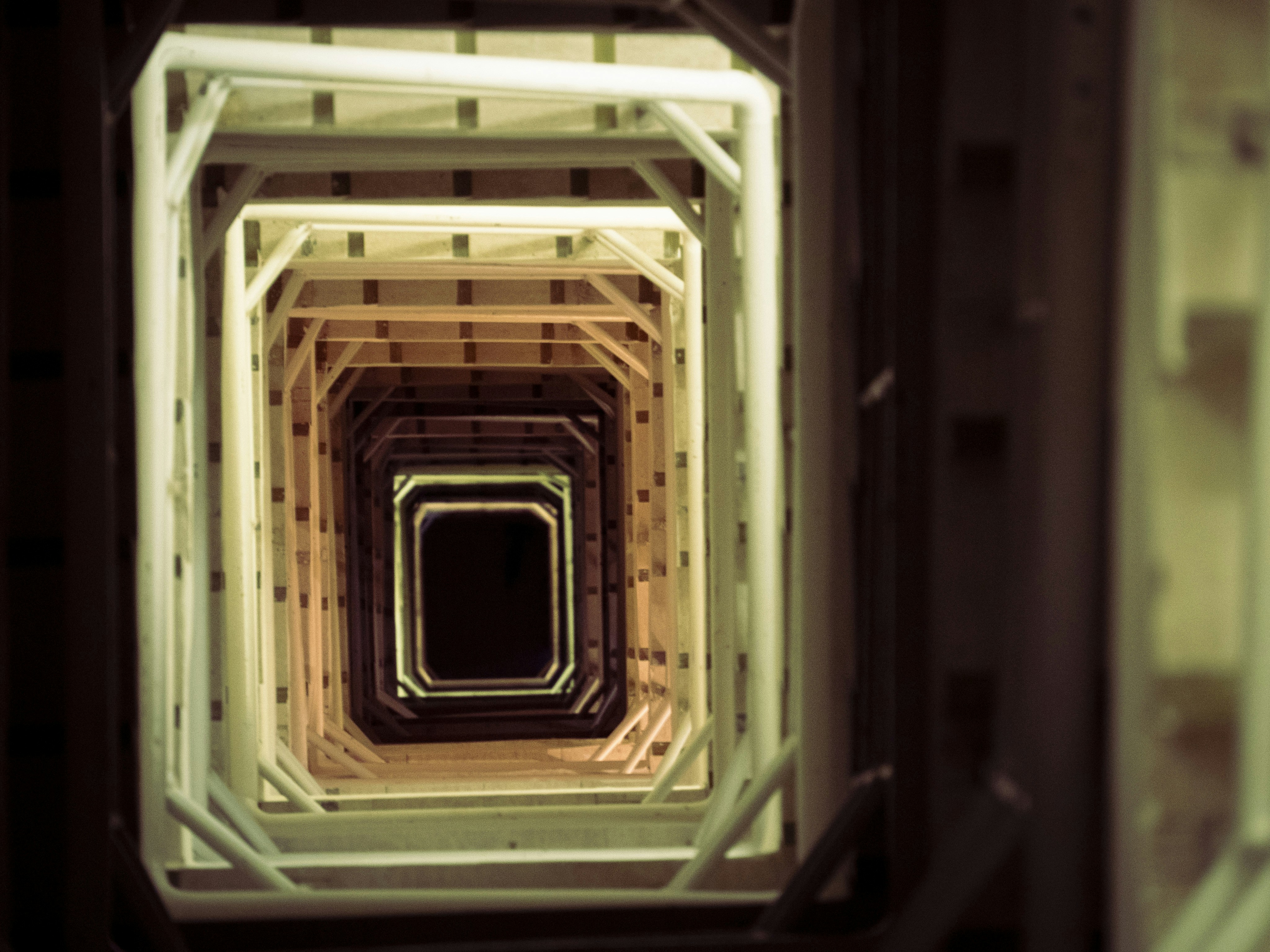 A dark tunnel with rectangular, light-framed openings.