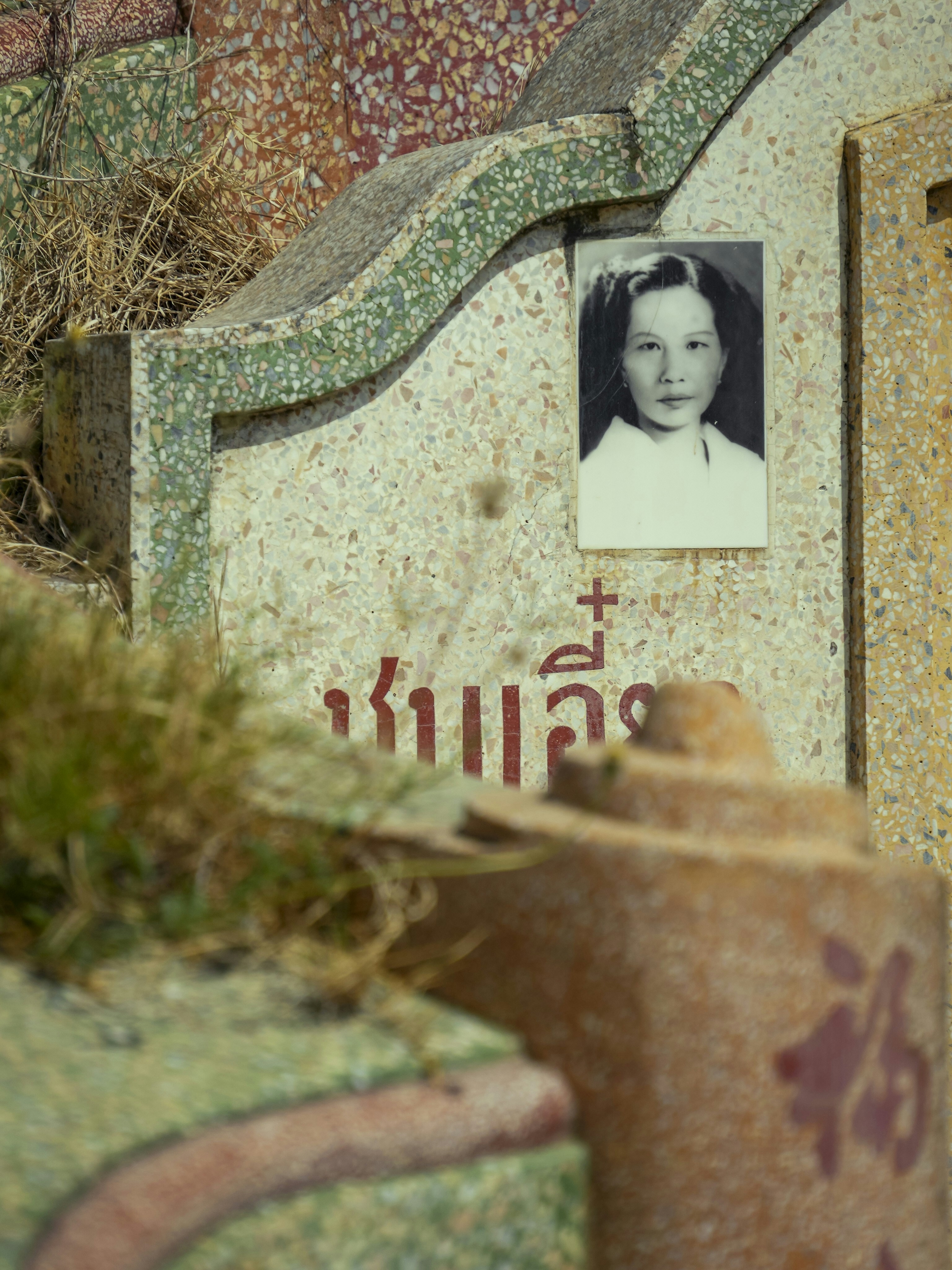 A grave with a photograph and inscriptions.