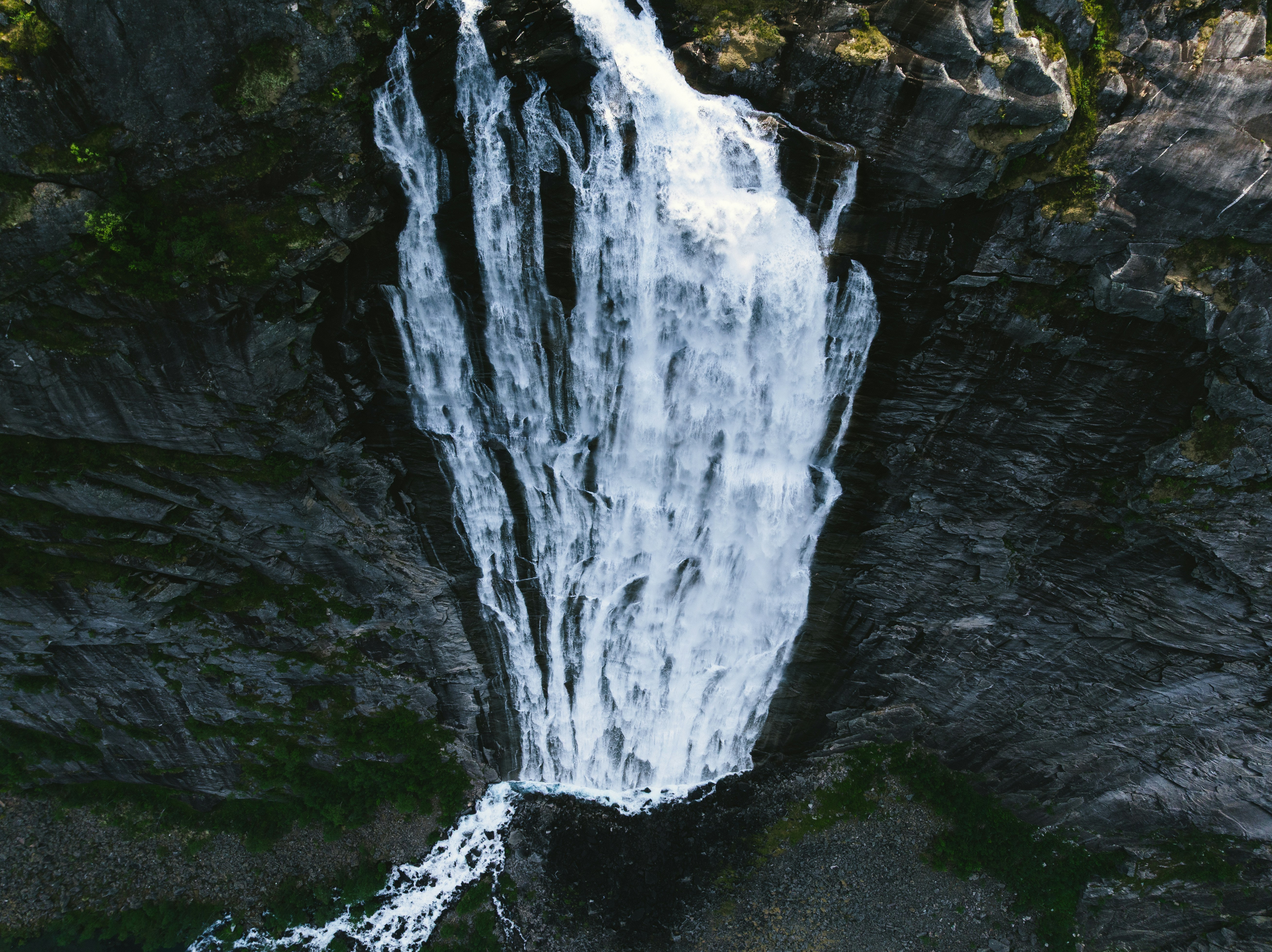 A majestic waterfall cascades down rocky cliffs.