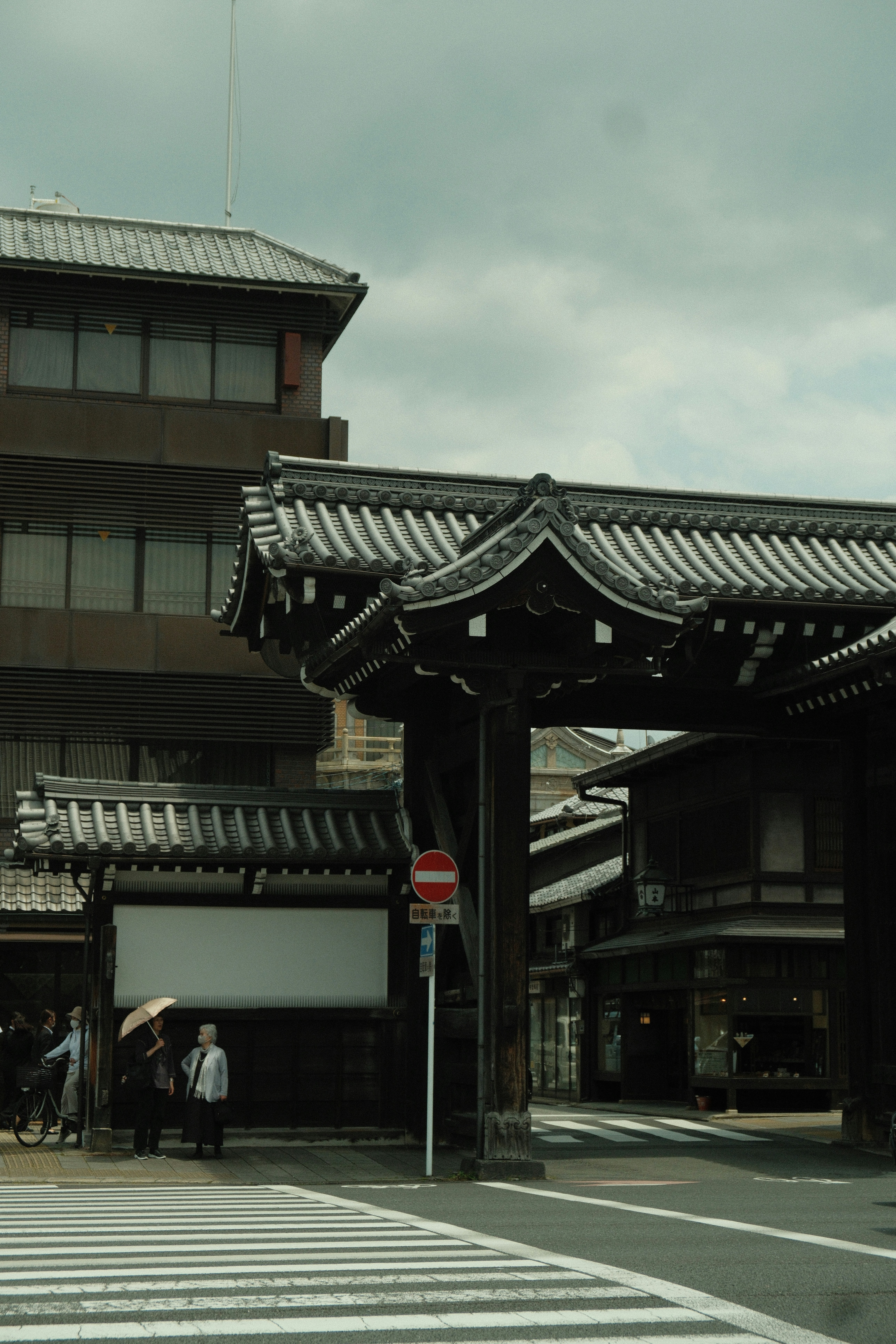 Traditional japanese gate with modern buildings in the background ...