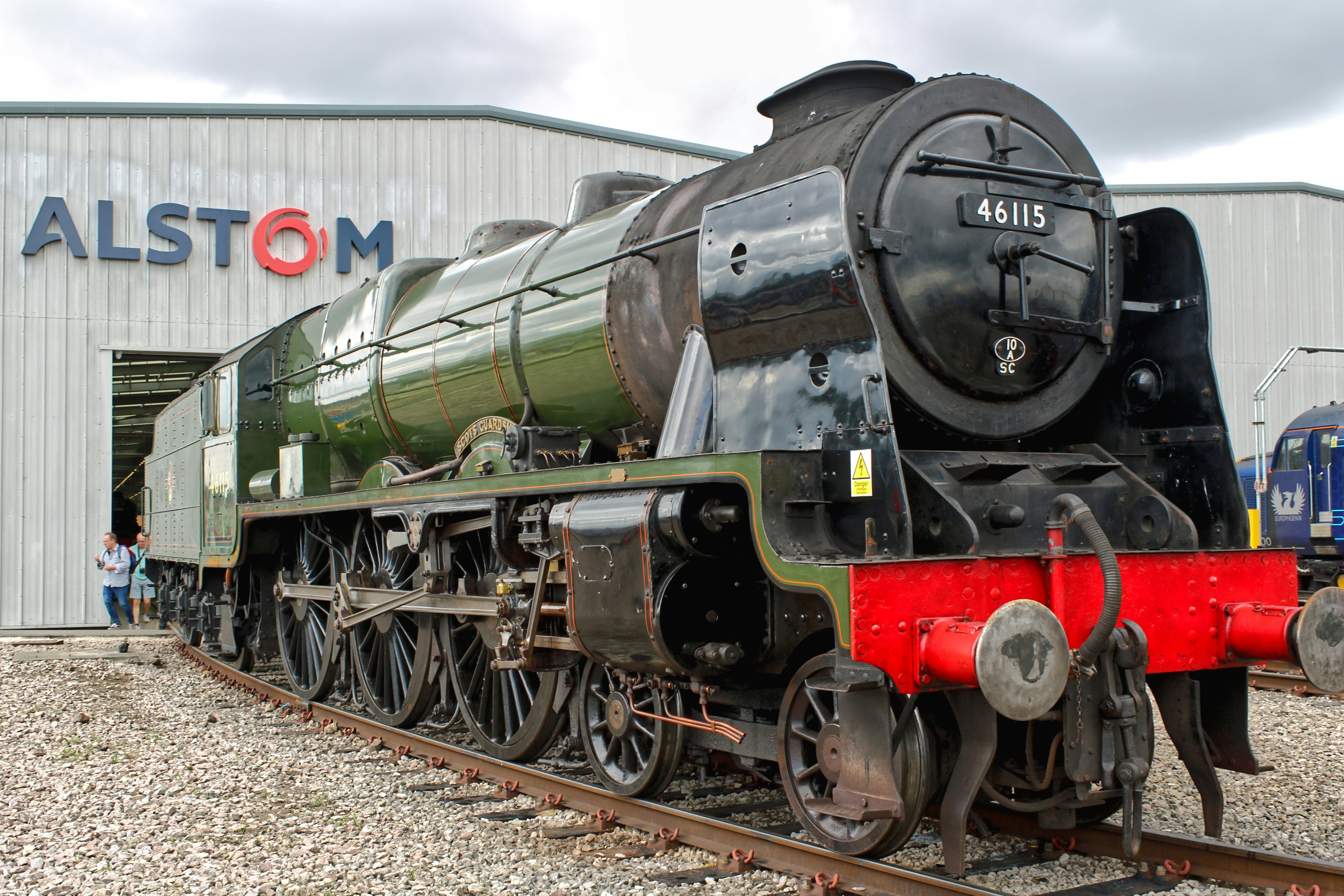 46115 'Scots Guardsman' @ The Greatest Gathering 2025 | A green steam train stands in front of a building.