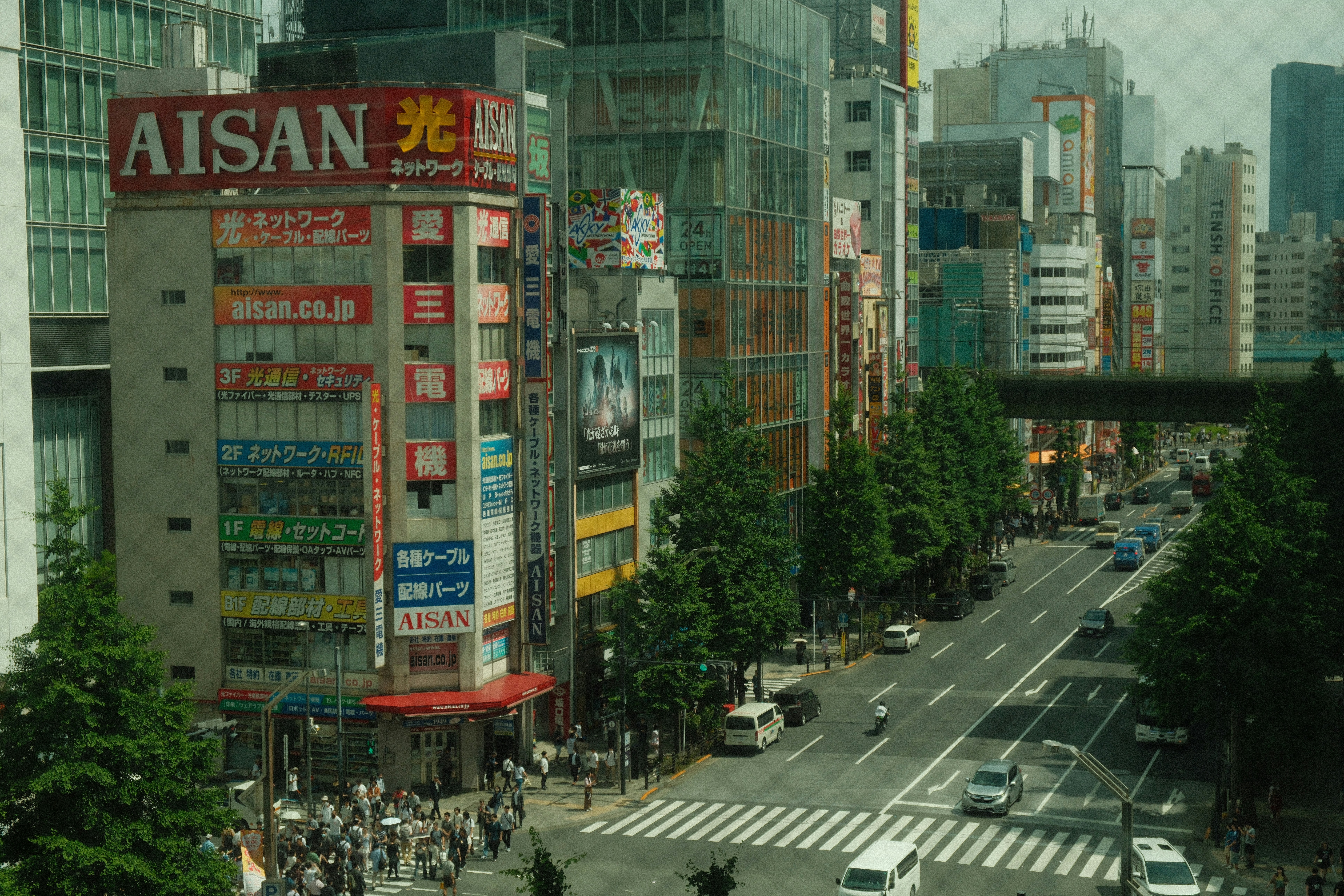 Vibrant street scene showcasing a busy intersection and commercial buildings, highlighting the dynamic energy of urban life.