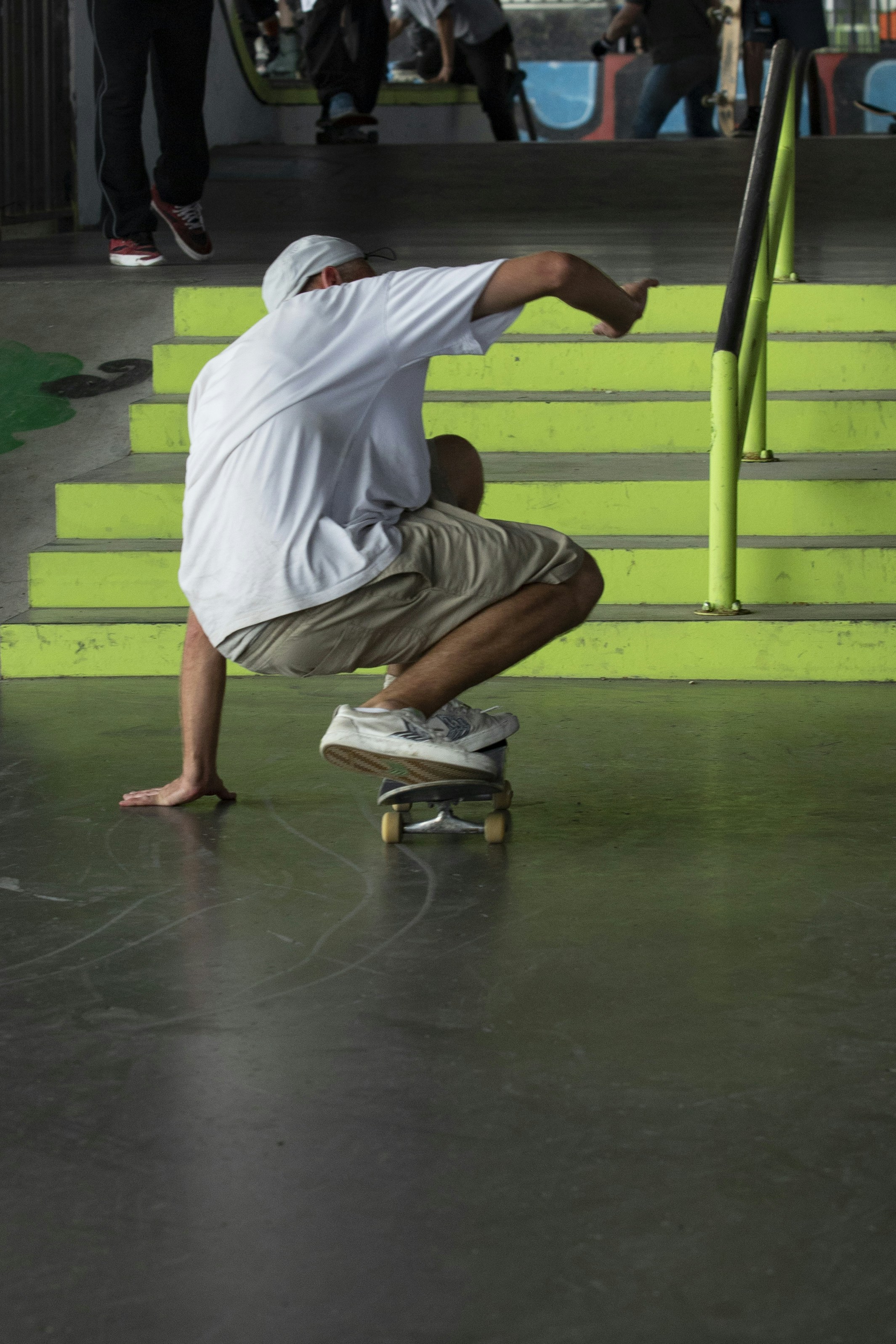 A skateboarder performs a trick at a skatepark.