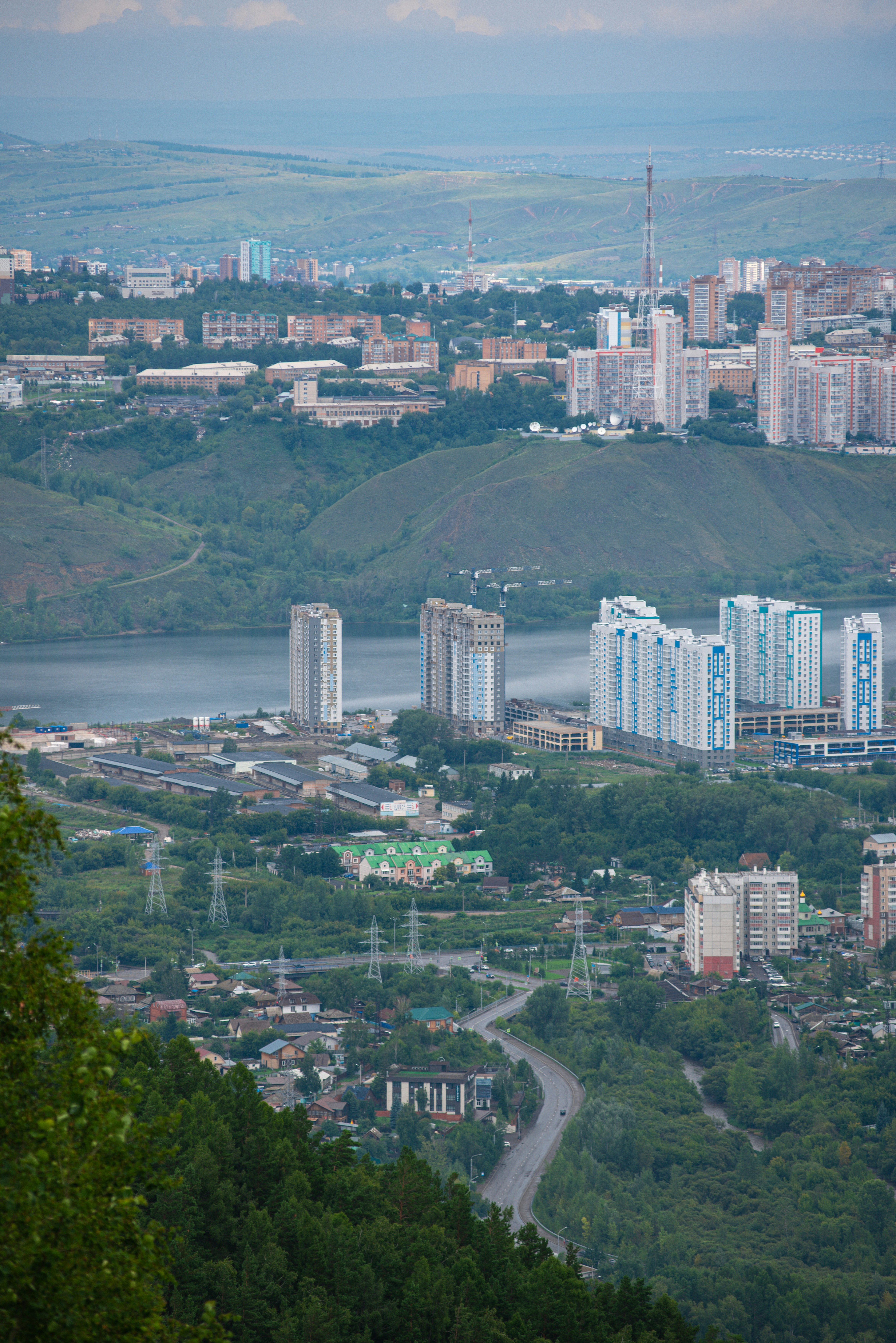 An aerial view of a city nestled among hills.